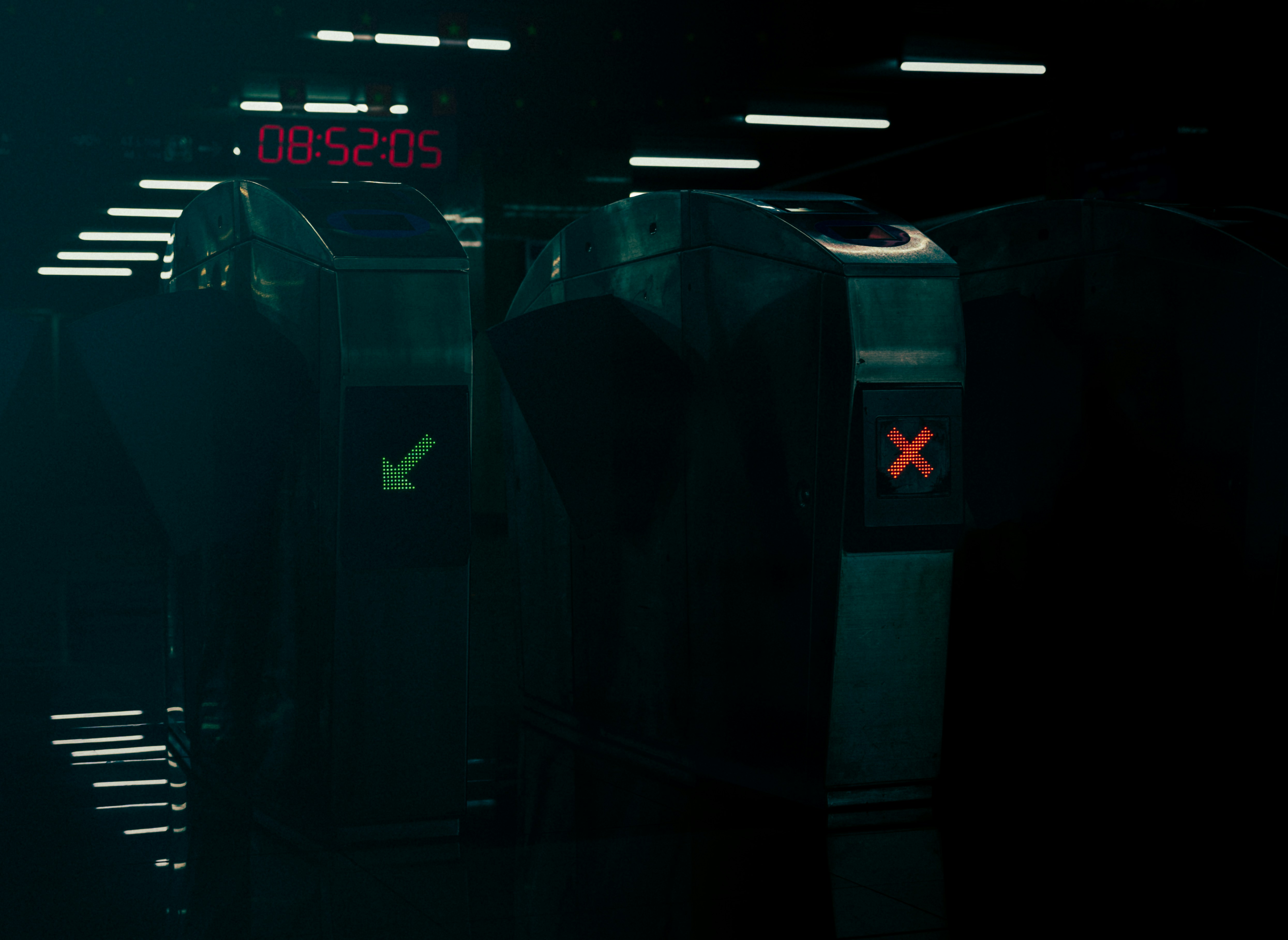 Turnstiles with green arrow and red cross.