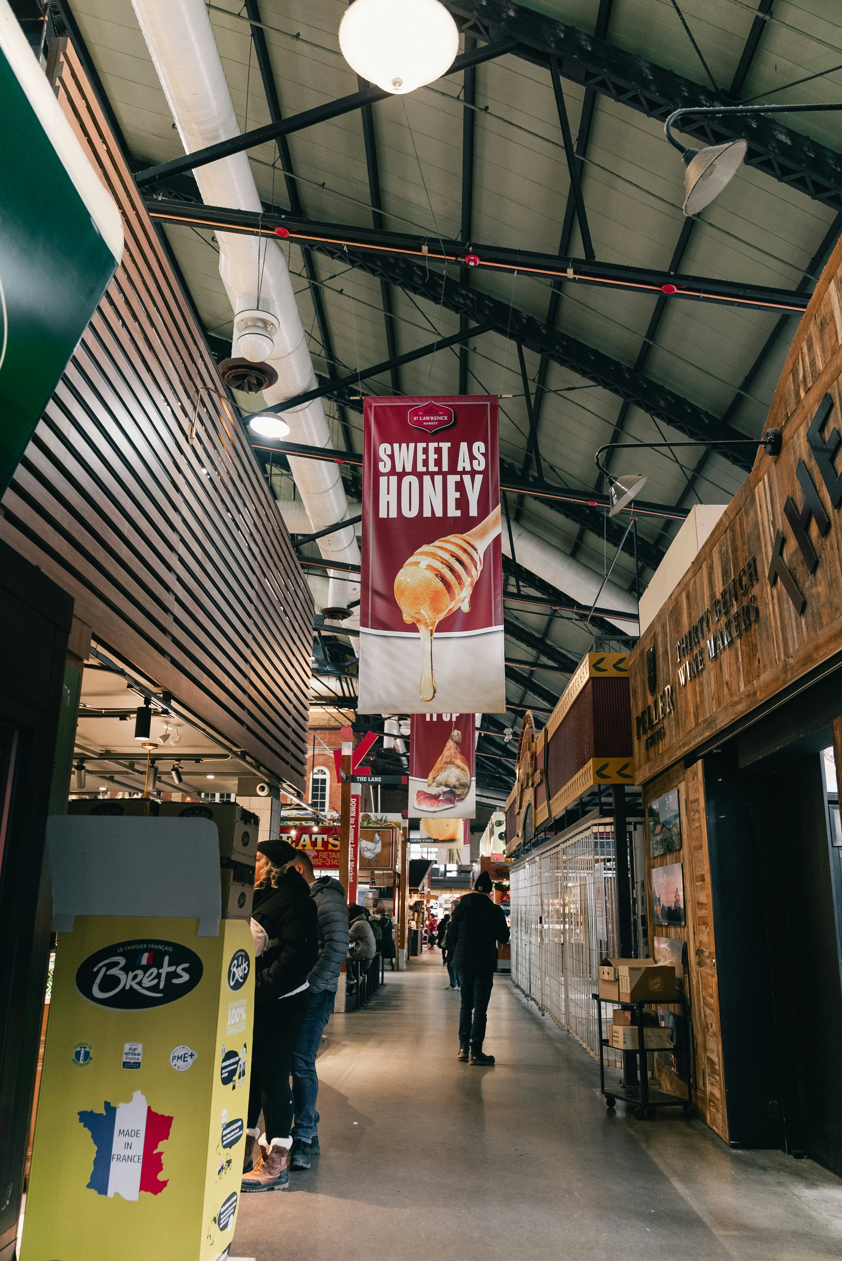 Sweet As Honey Banner Over a Market Corridor