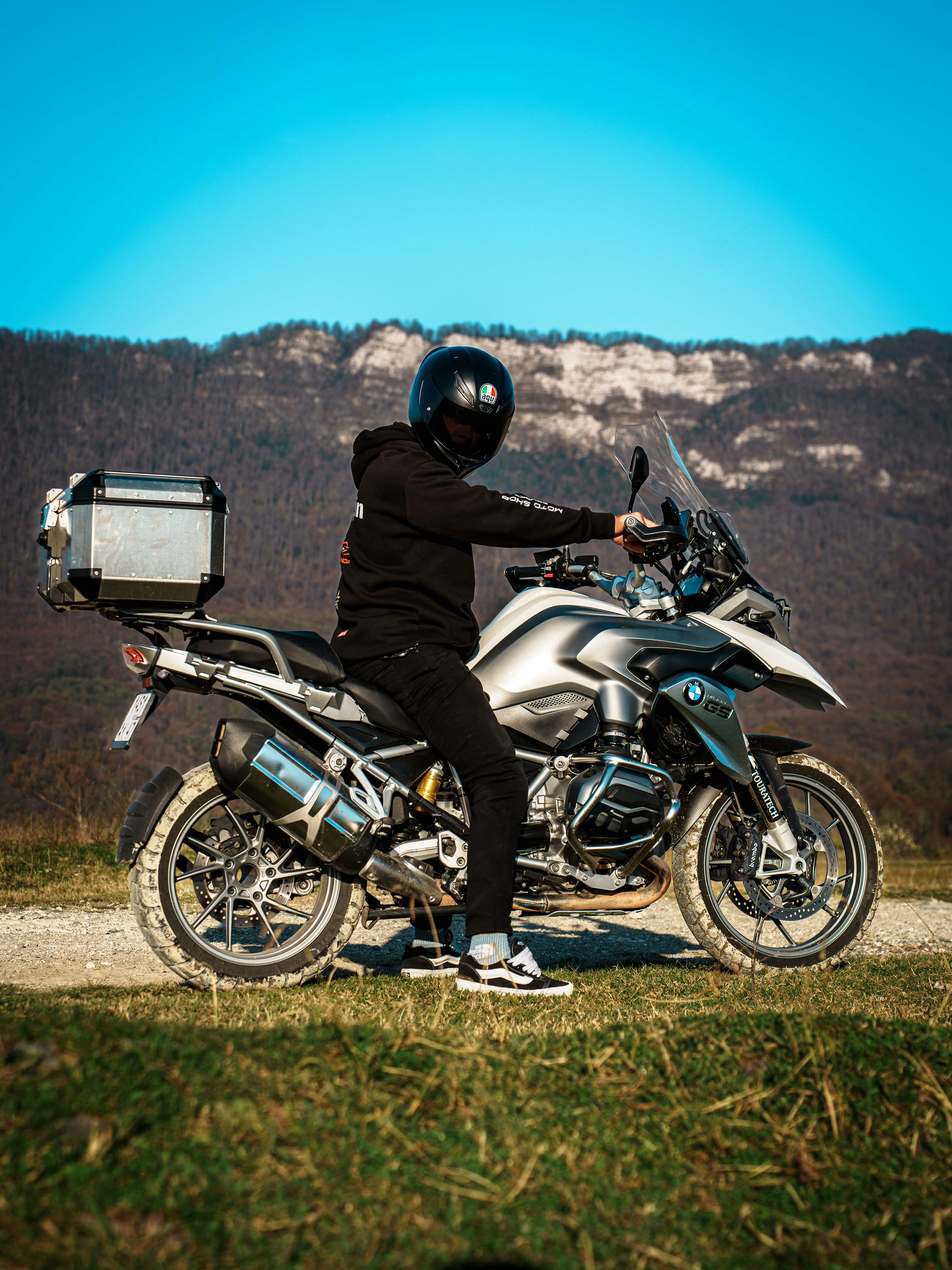 Person in helmet sits on a silver motorcycle photo – Free Freedom Image ...