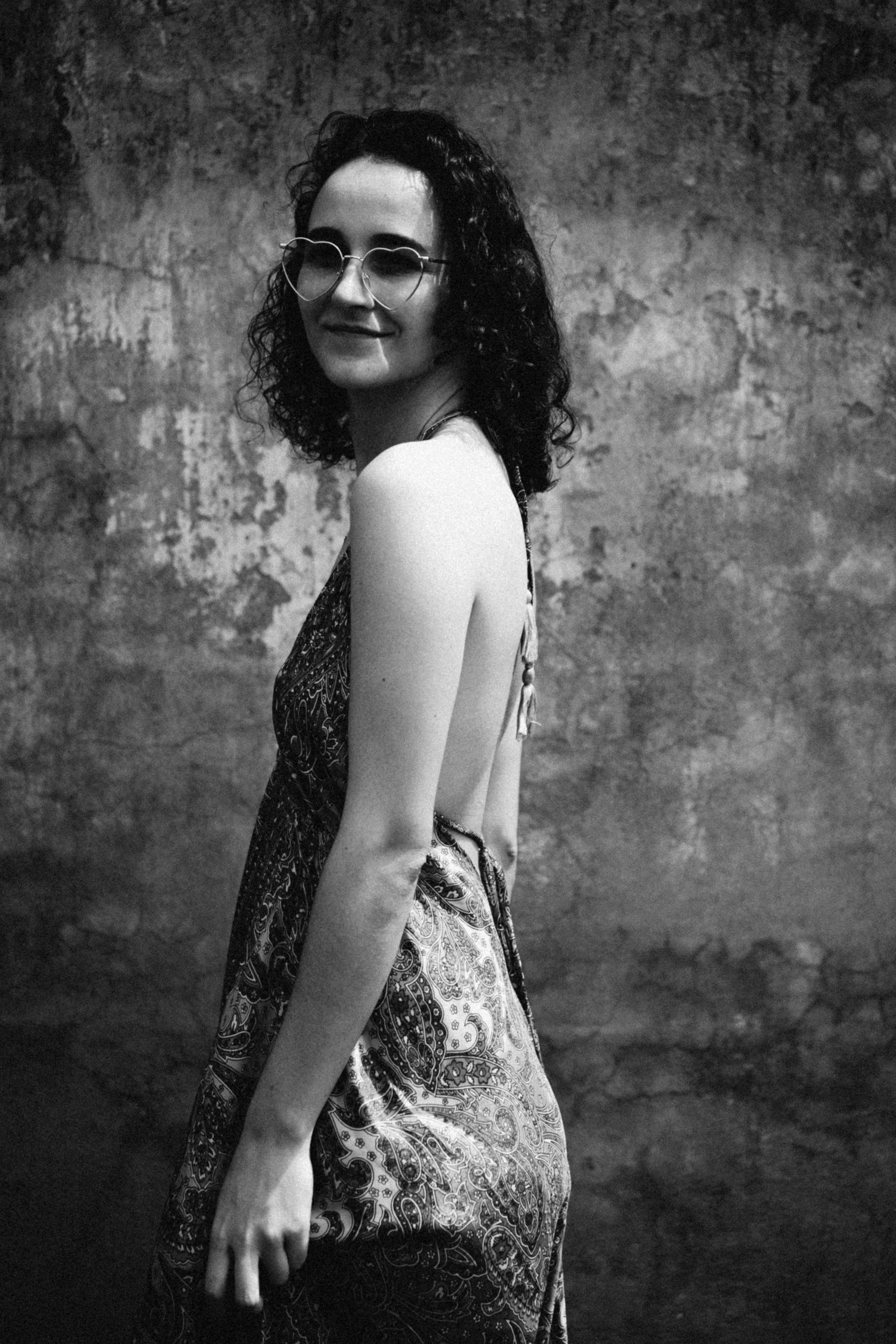 Quiet Confidence in Mono: A Vintage Portrait against a Weathered Wall