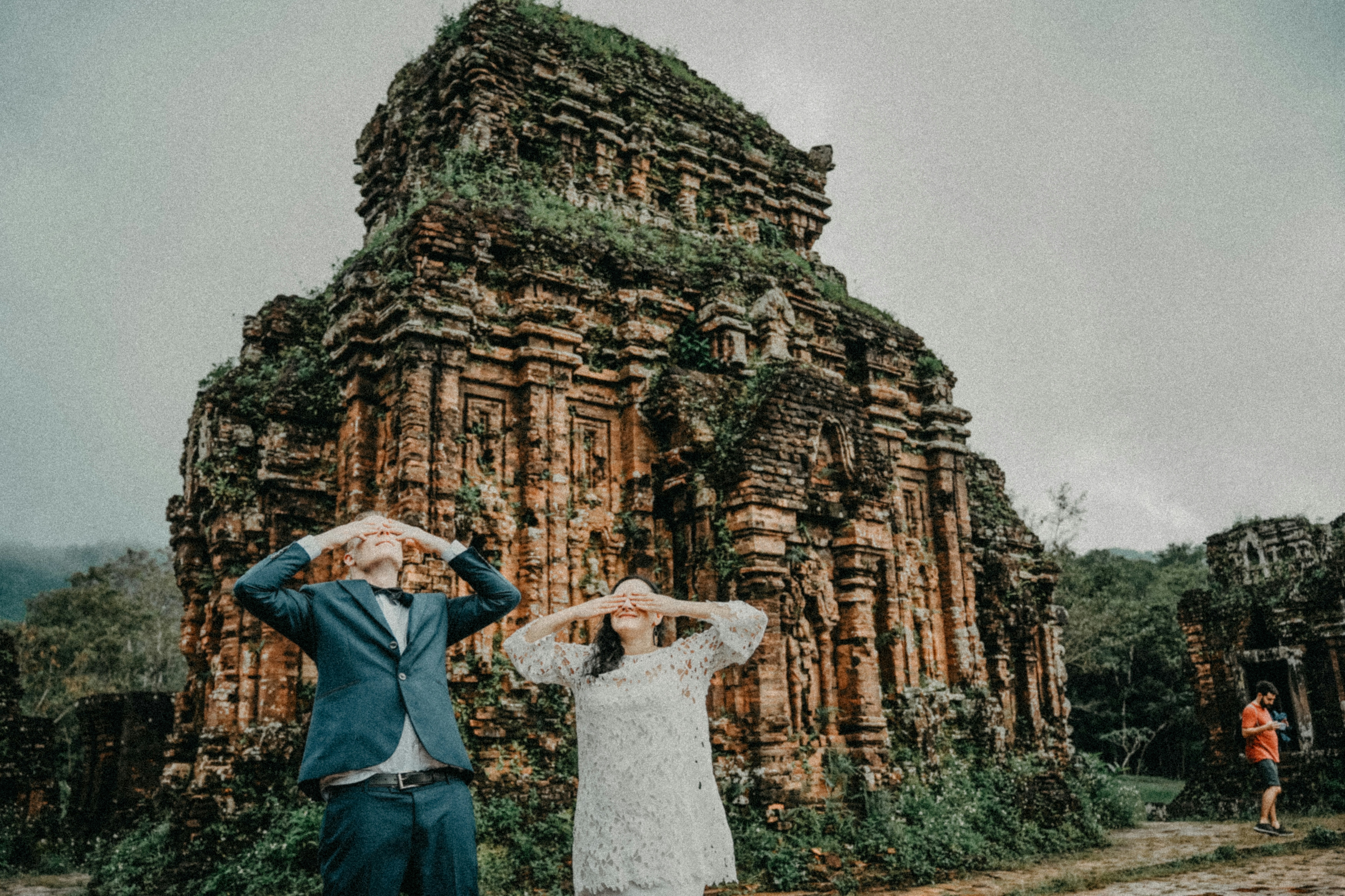 Ancient Ruins, Modern Poses: A Couple Stands Guard by Weathered Towers