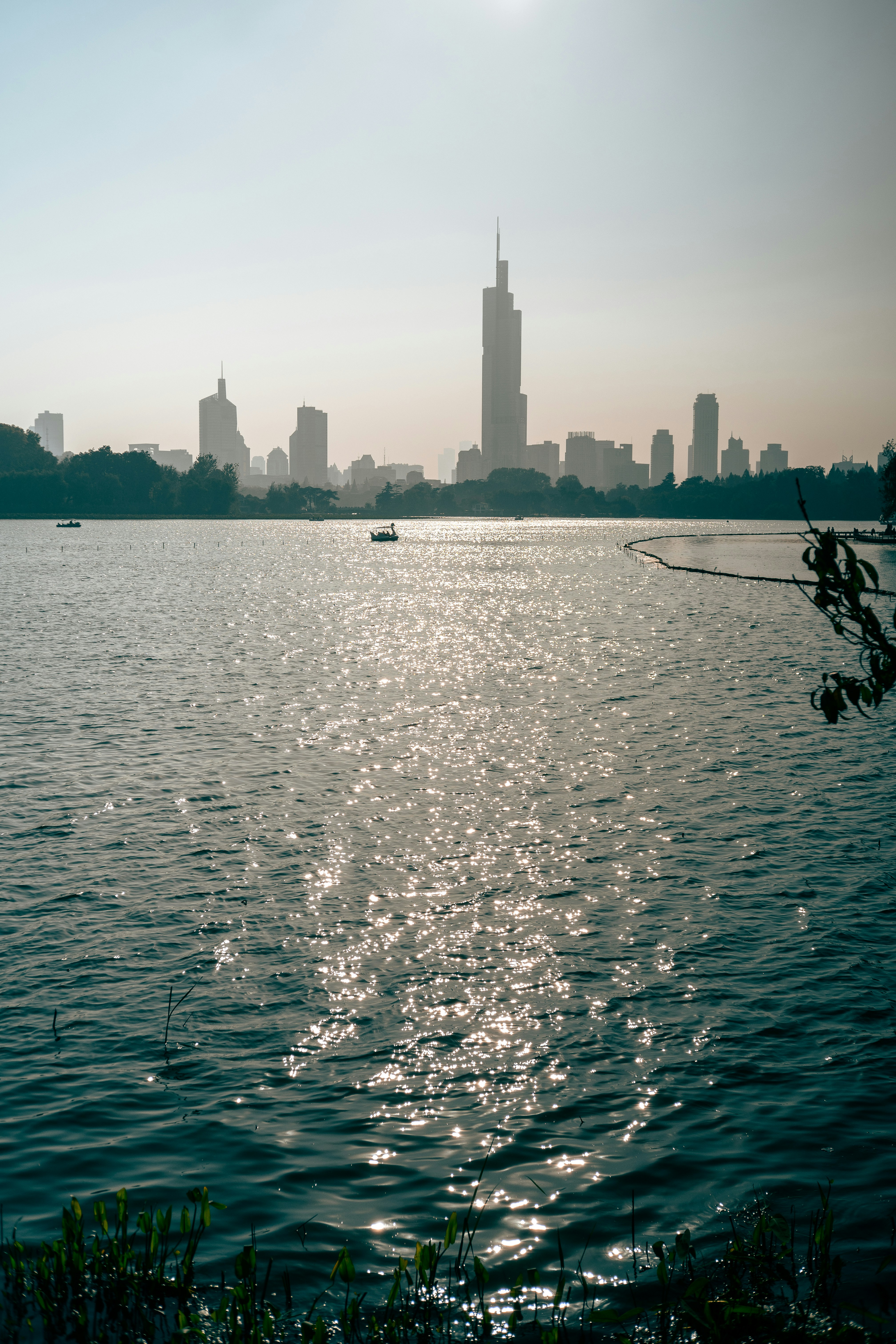 Rising Skyline over a Glimmering Lake at Dusk