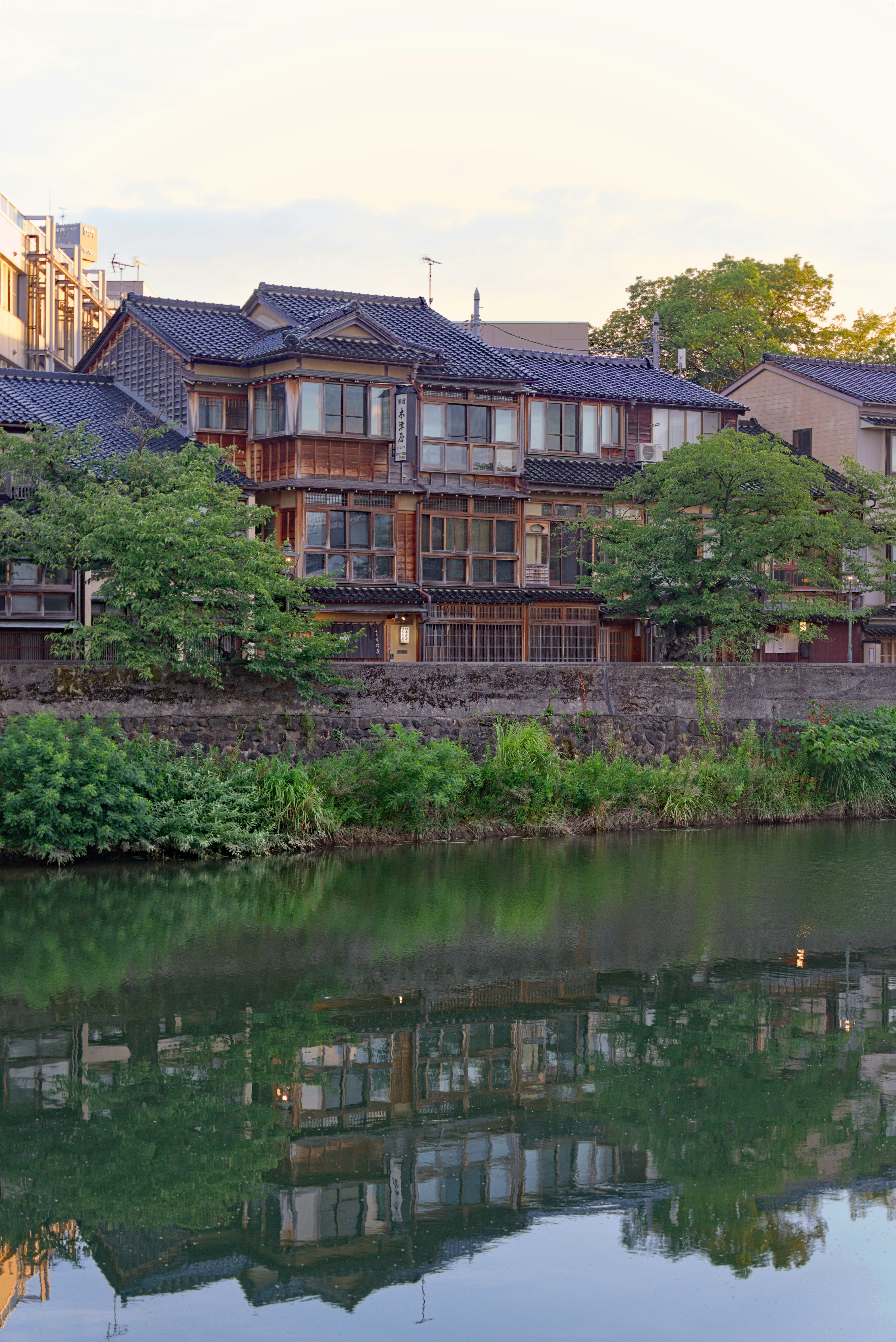 Riverside Row of Traditional Townhouses Reflecting in Evening Water