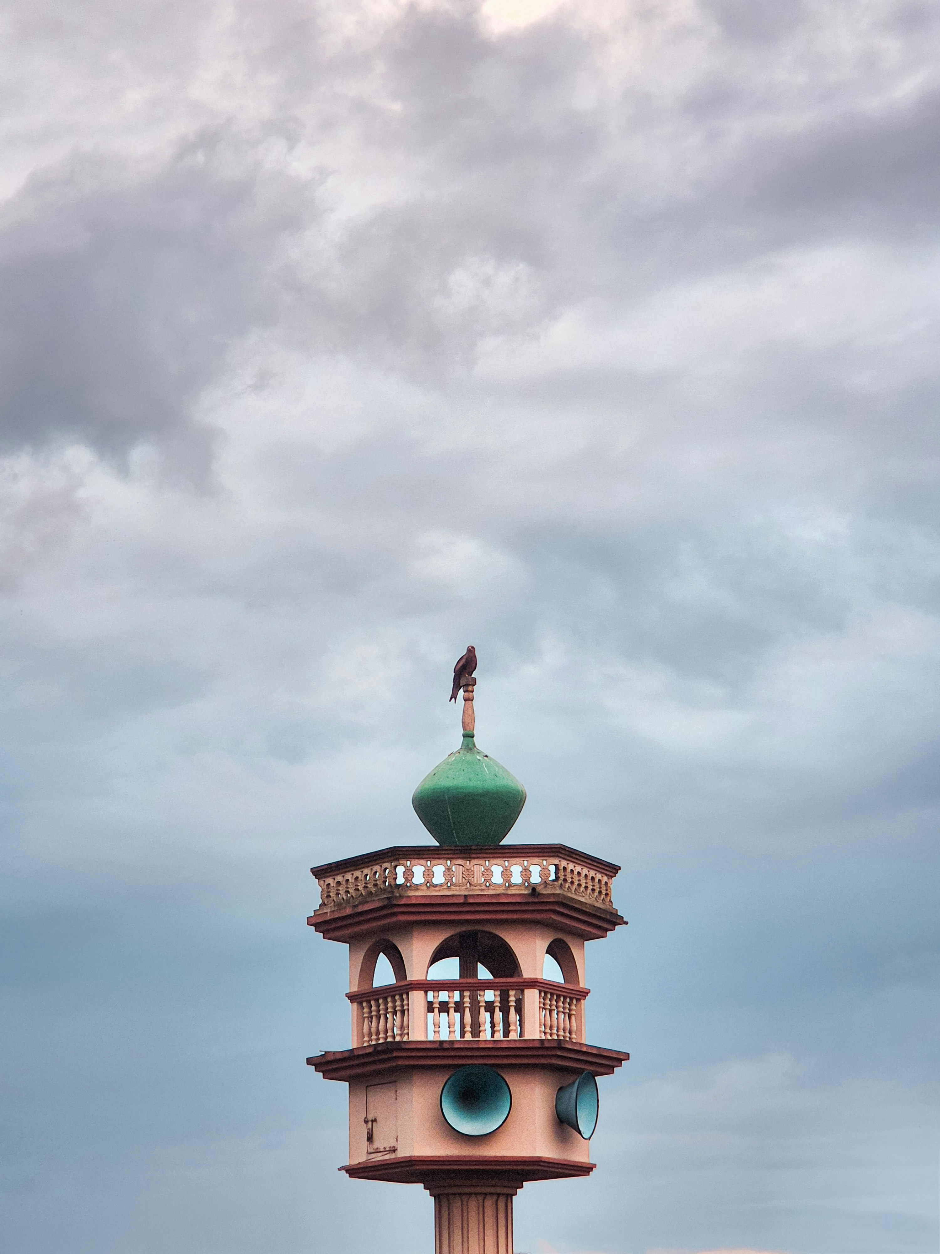 Spire Crown: A Teal Turret Rises Against a Stormy Sky