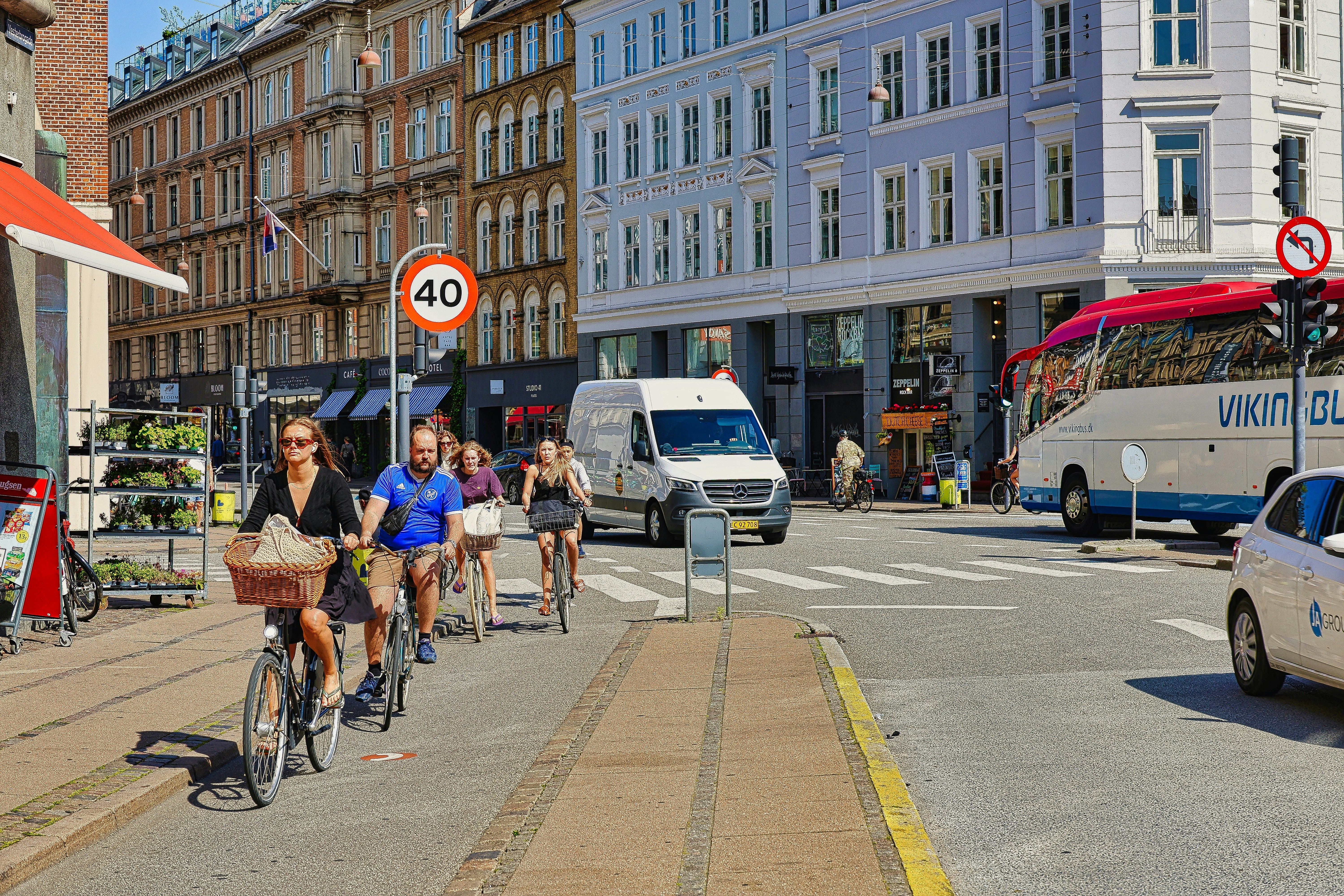 City Cyclists and Courtyard Sunlight on a Danish Street