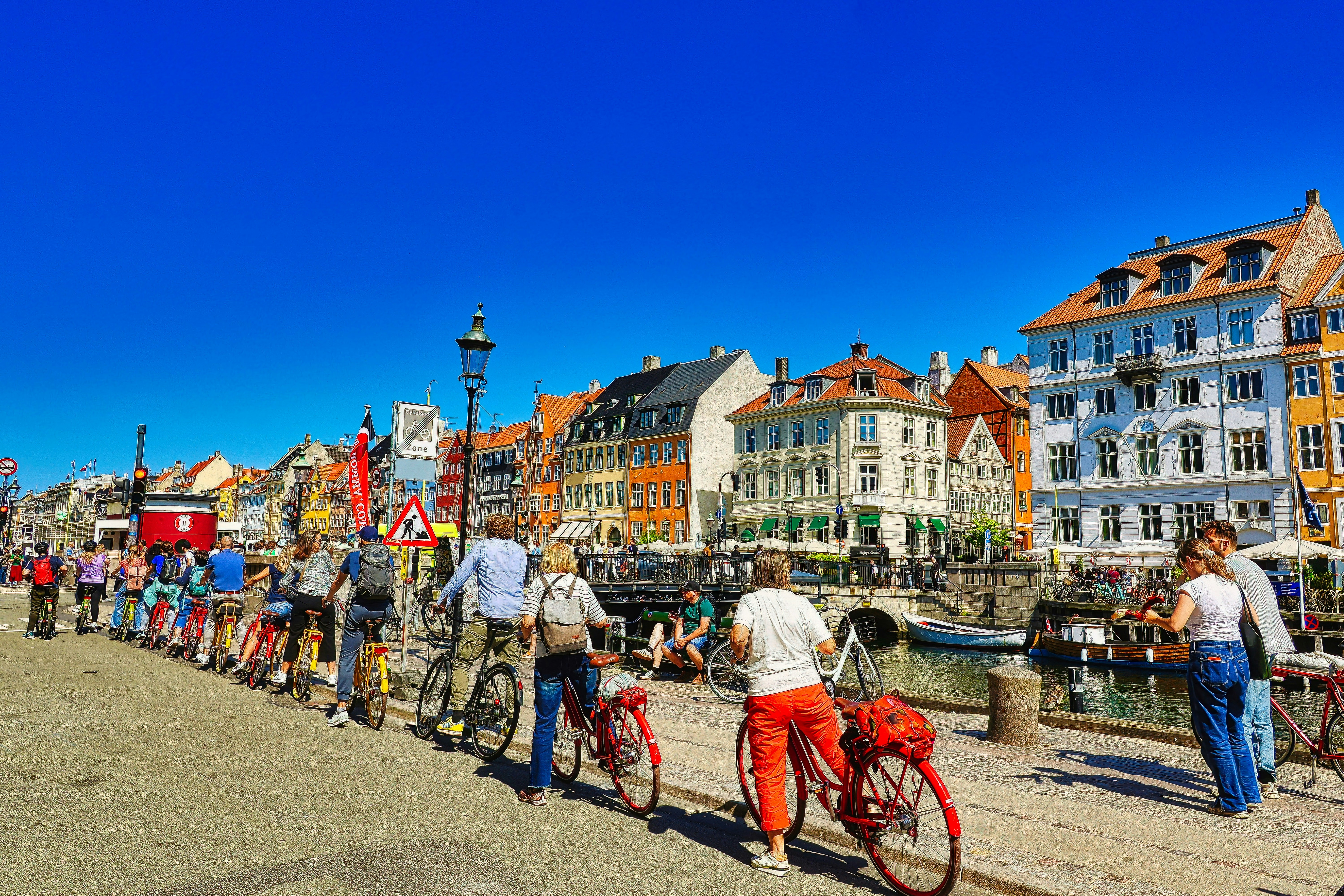 Bicycle Parade Along a Colorful Waterfront Boulevard