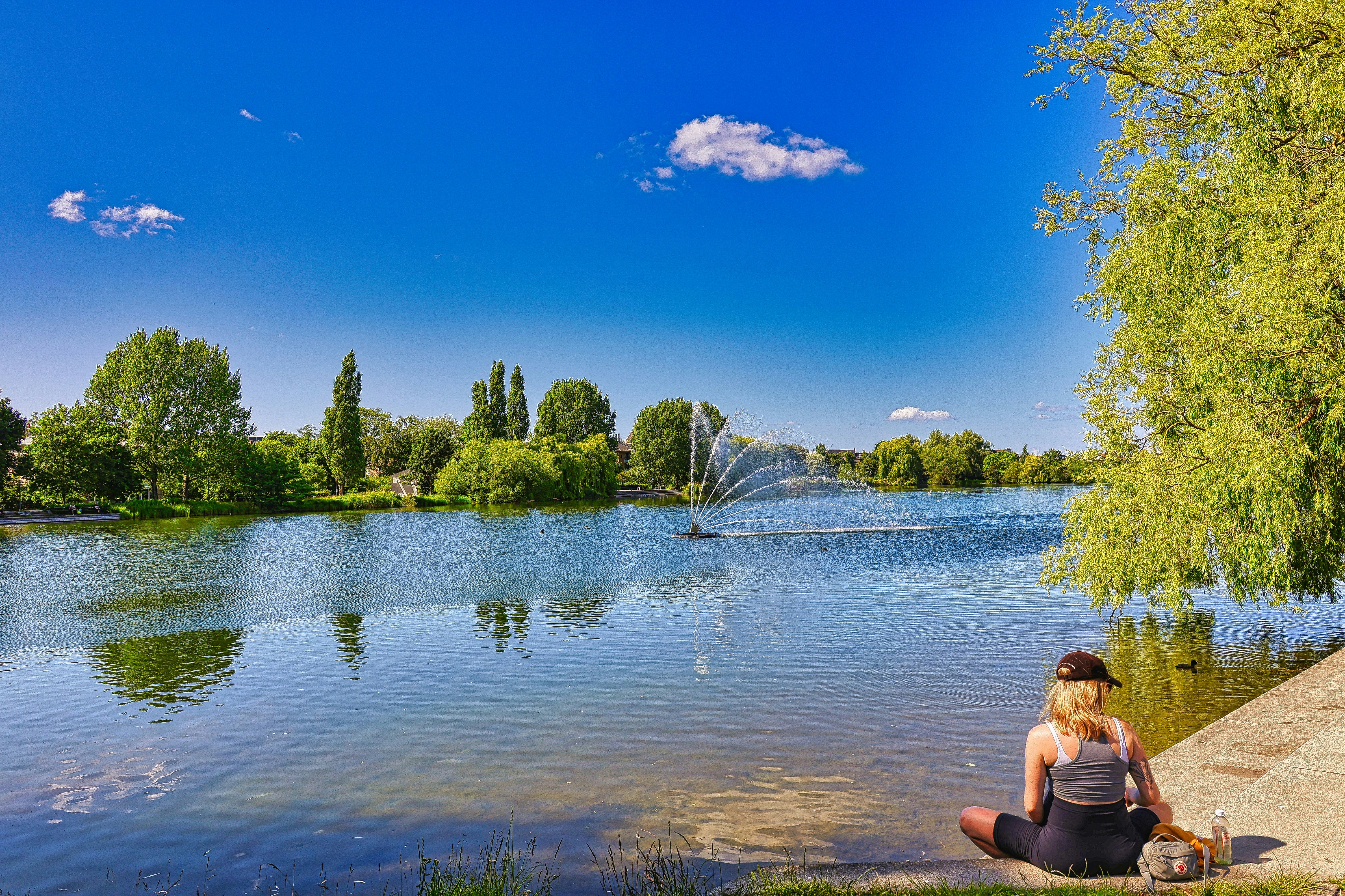 Quiet Shoreline: A Solitary Seeker by the Fountain