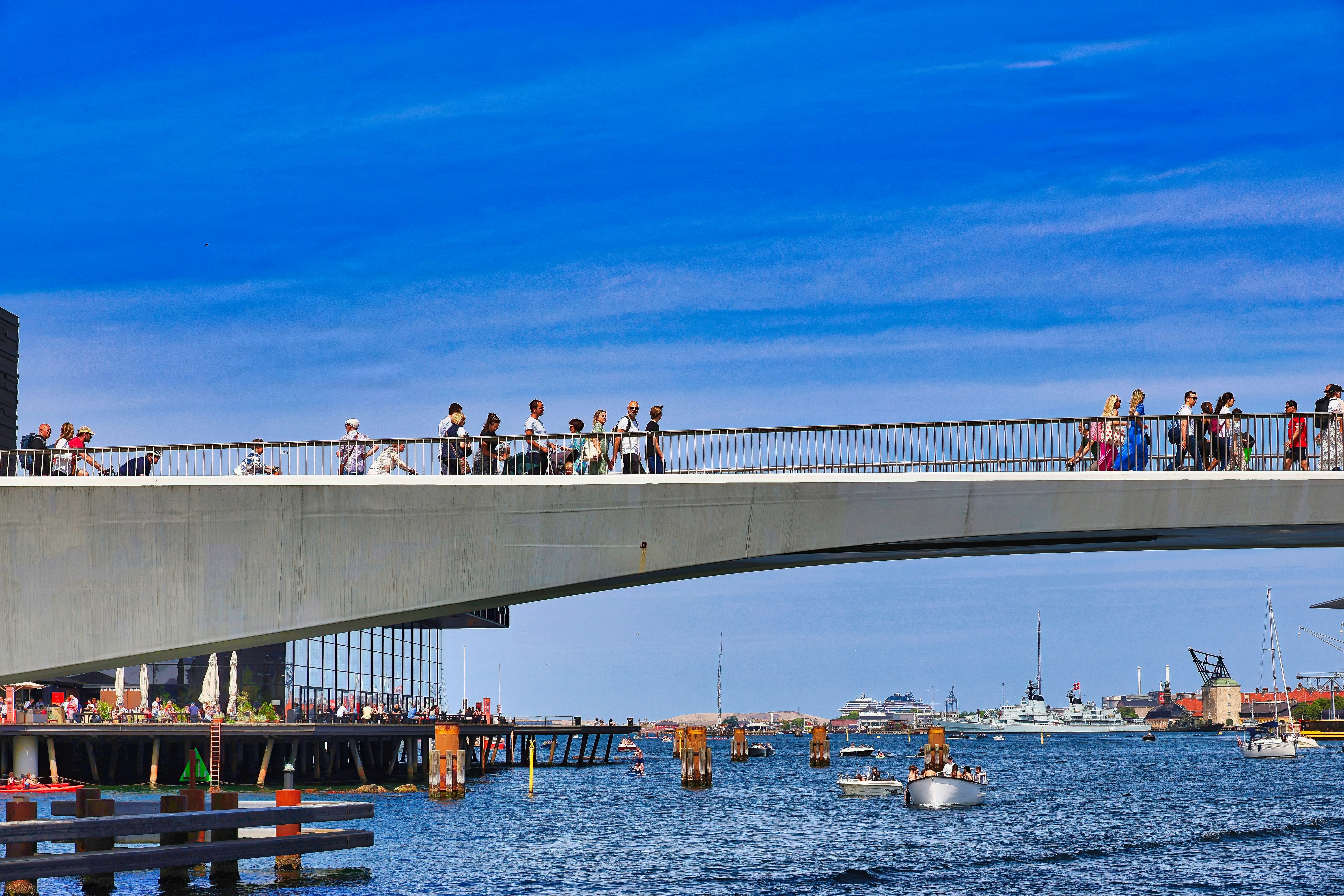 Pedestrian Bridge Over Waterfront: A Corridor of People Beyond the Curved Span