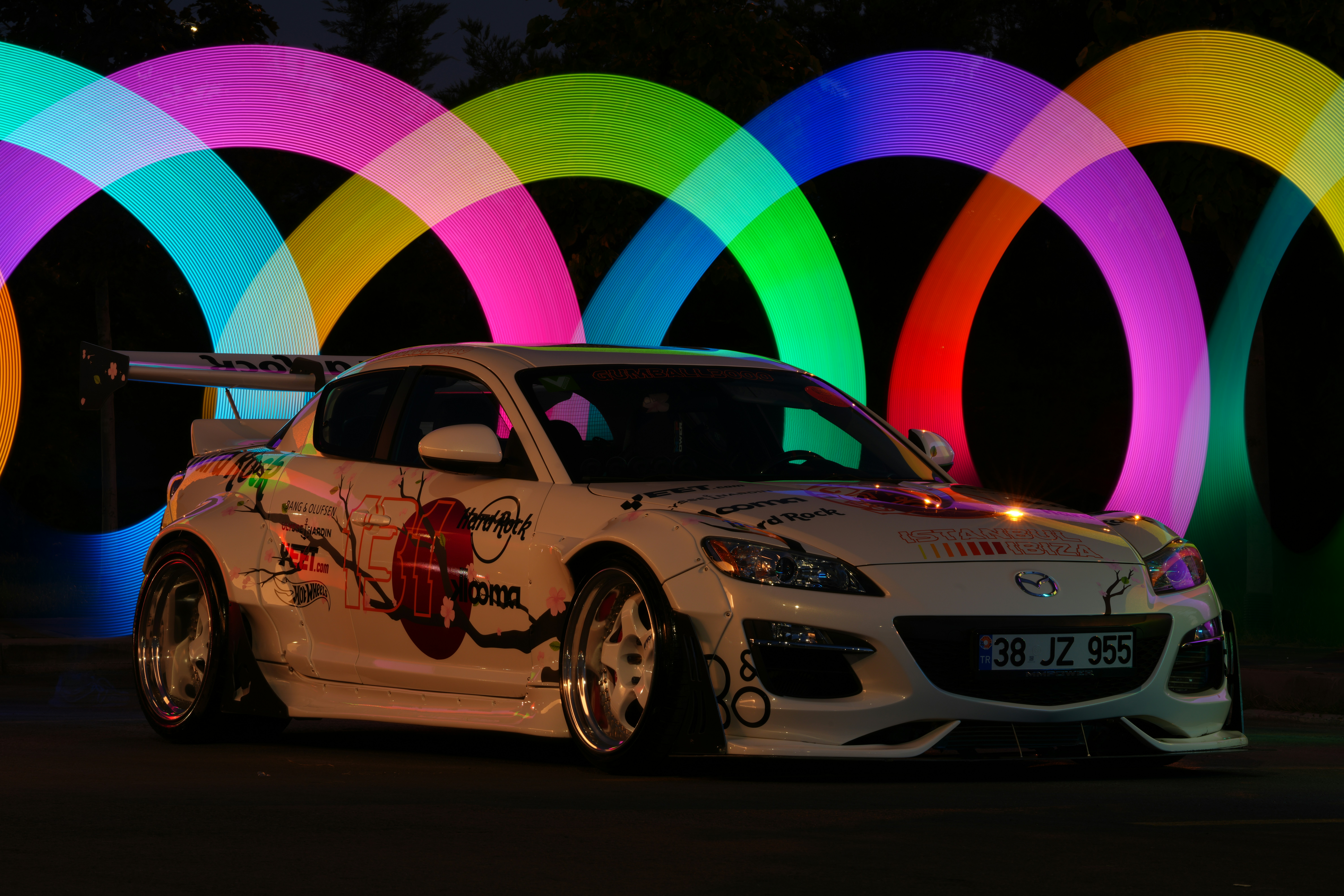 Neon Arcs Overdrive: A Drift-Ready White Beast Under Colorful Rings