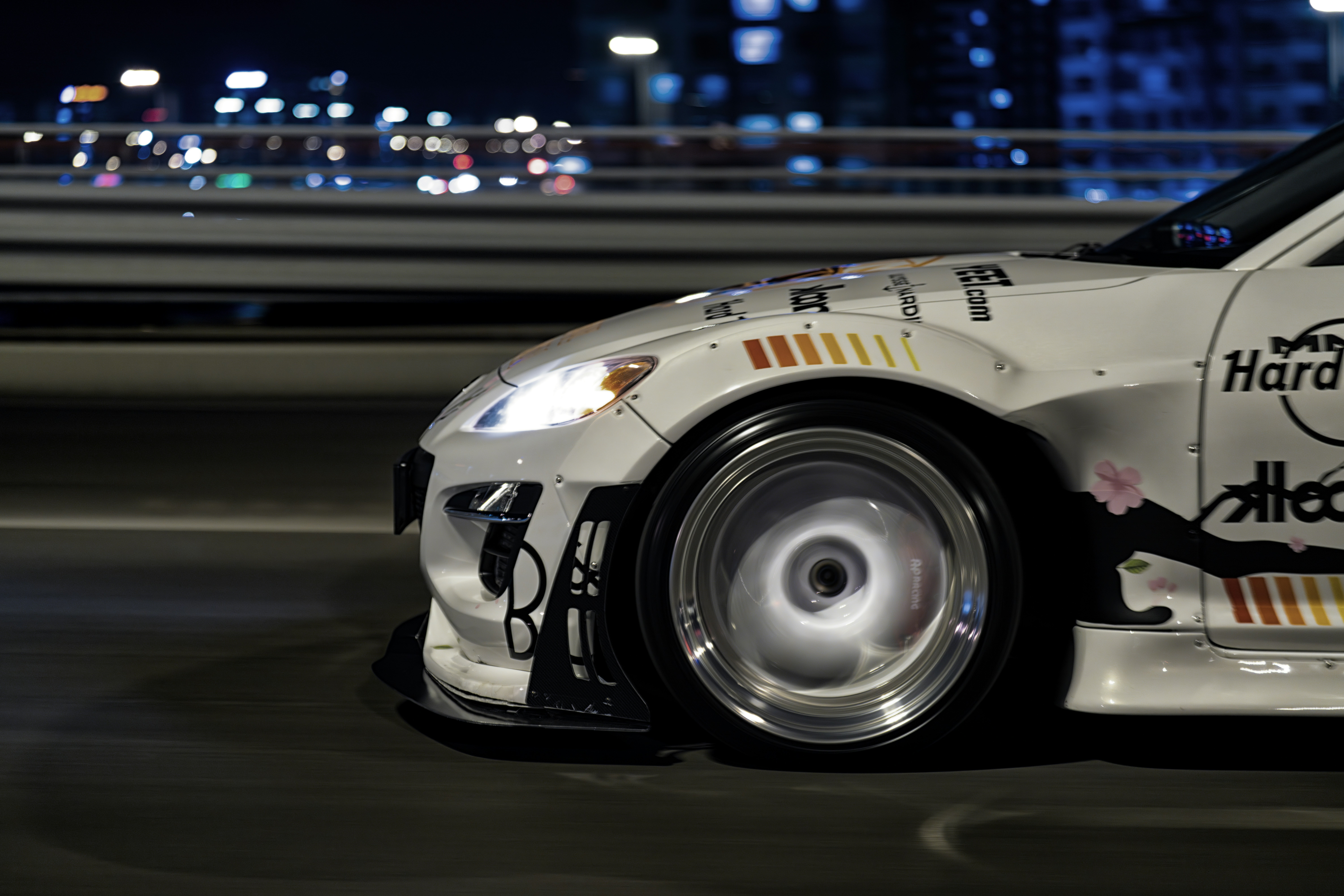 Night Drift: A White Race Car Hurls Forward Under City Lights