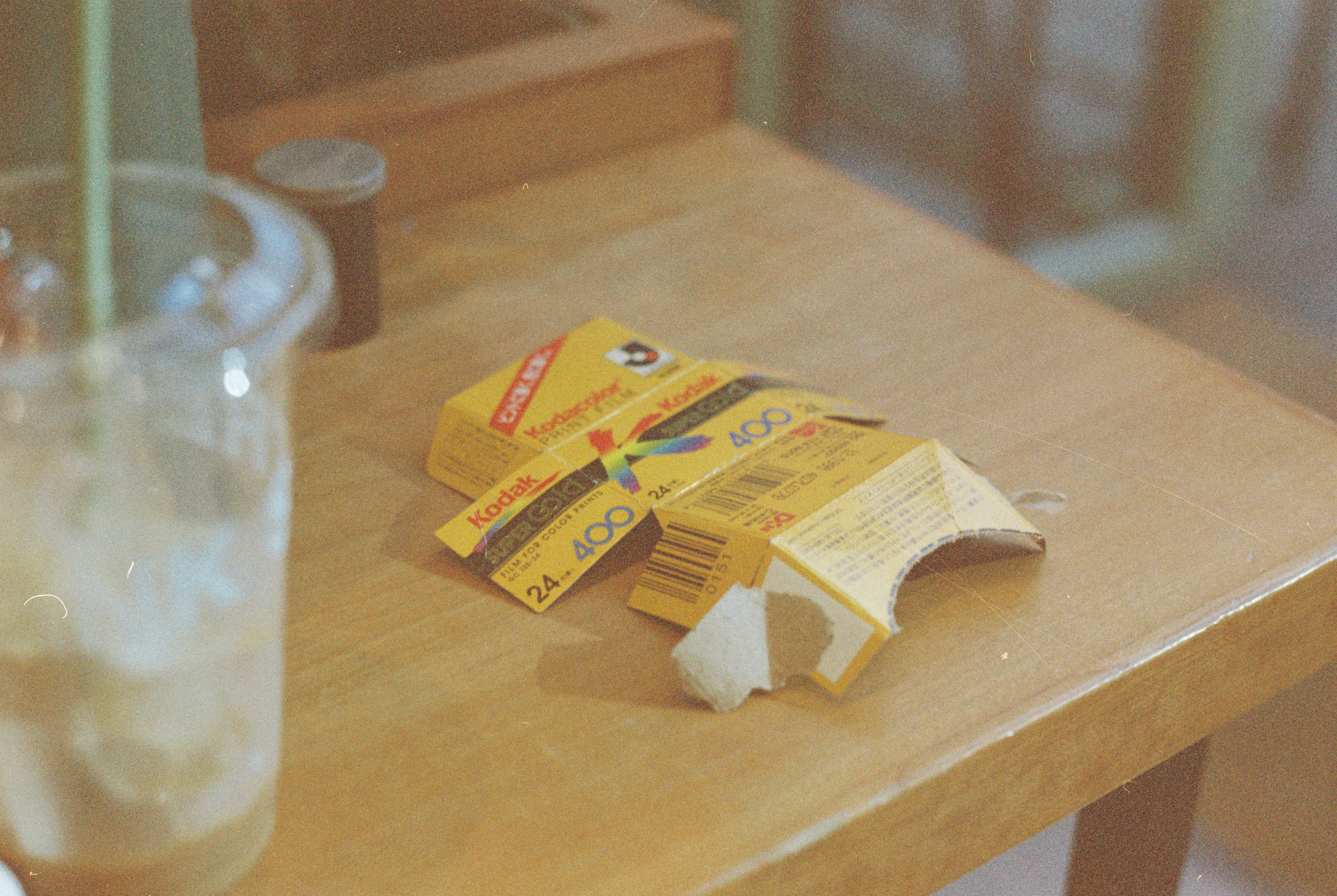 Sunlit, Crumpled Box Packets on a Wooden Table