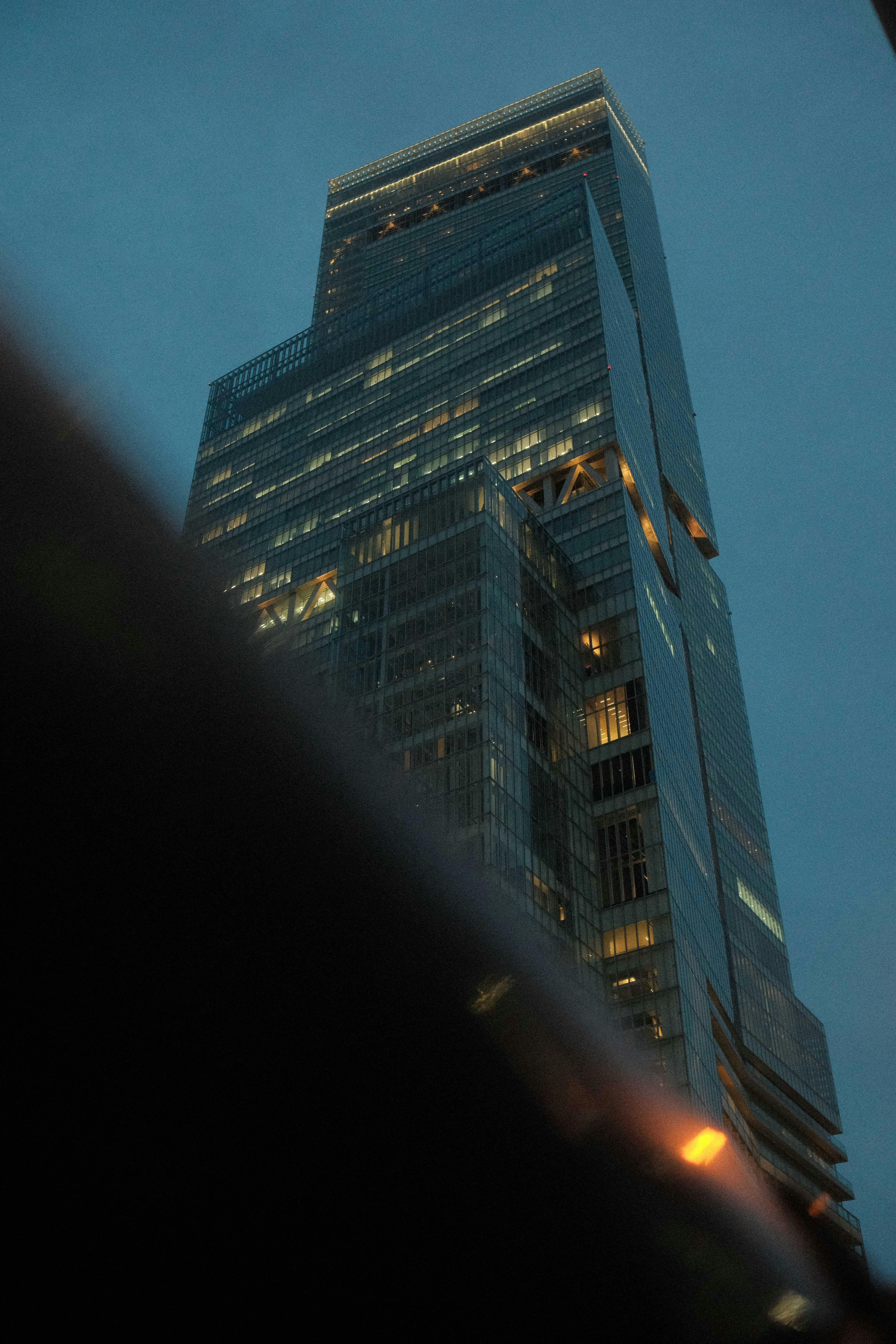 Skyscraper at Dusk: Geometric Glass Standing Above the Shadow
