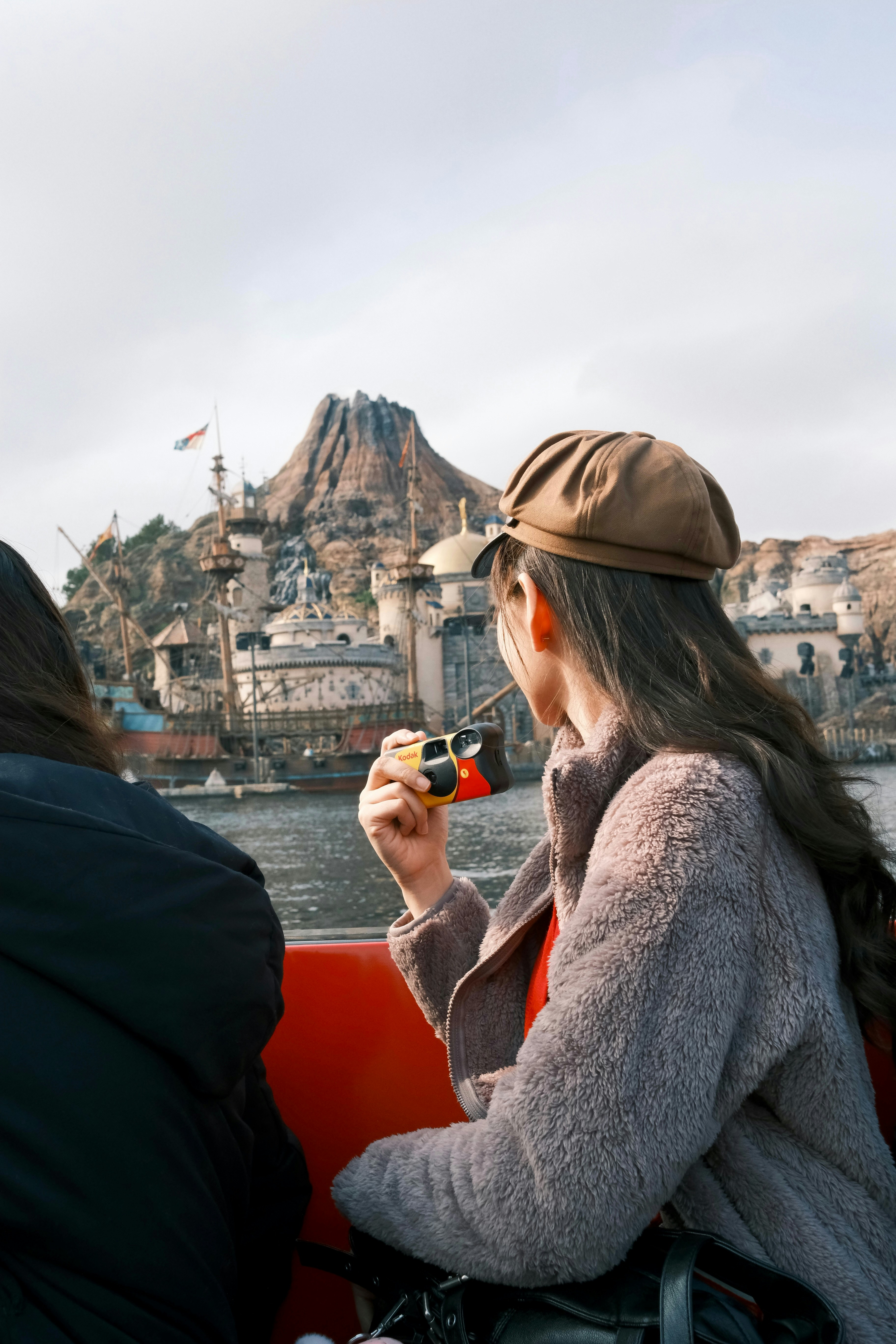 Lens of Curiosity: A Traveler Captures a Moment by the Enchanted Waterfront