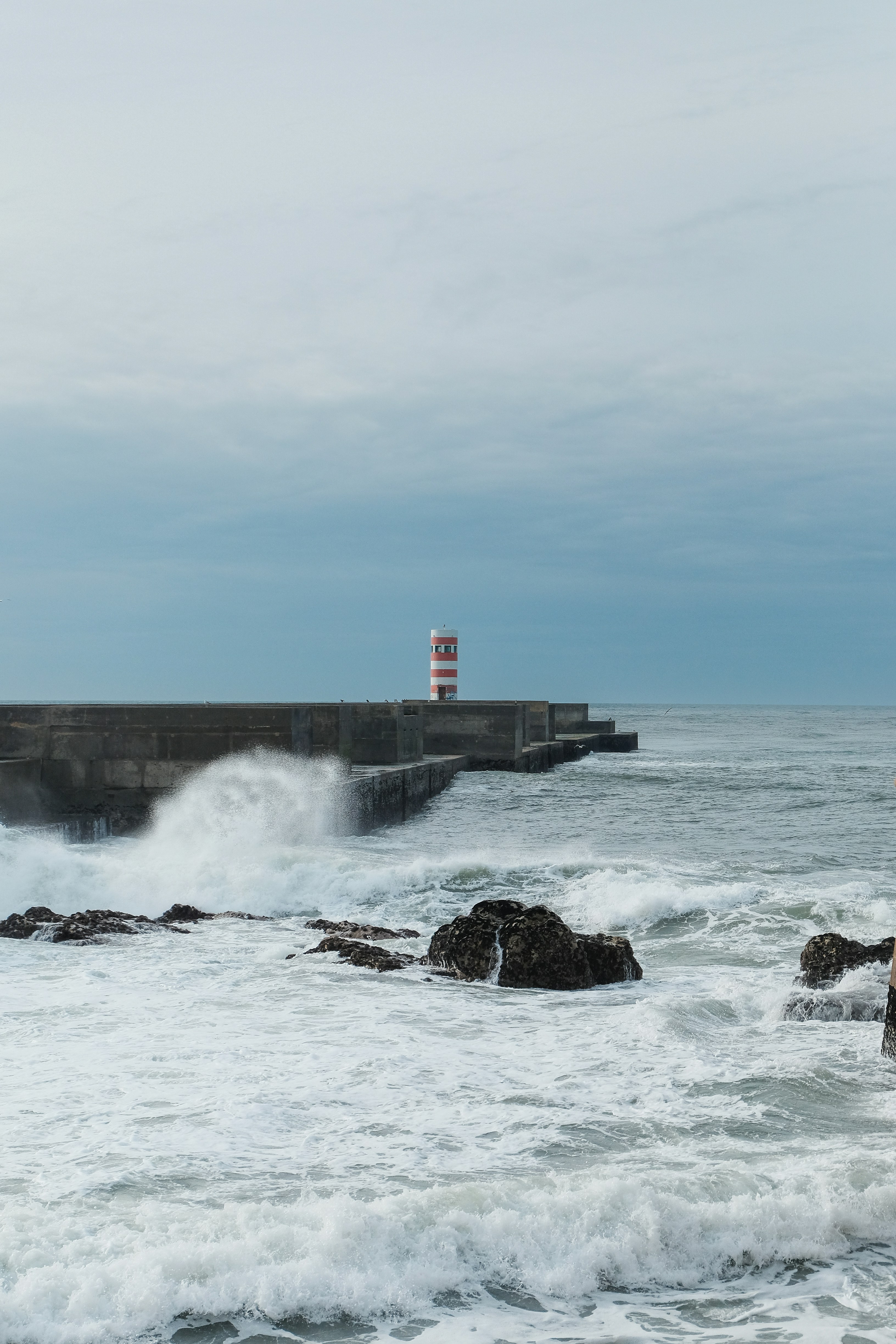 Lighthouse Standby: A Coastal Break Beyond the Jetty