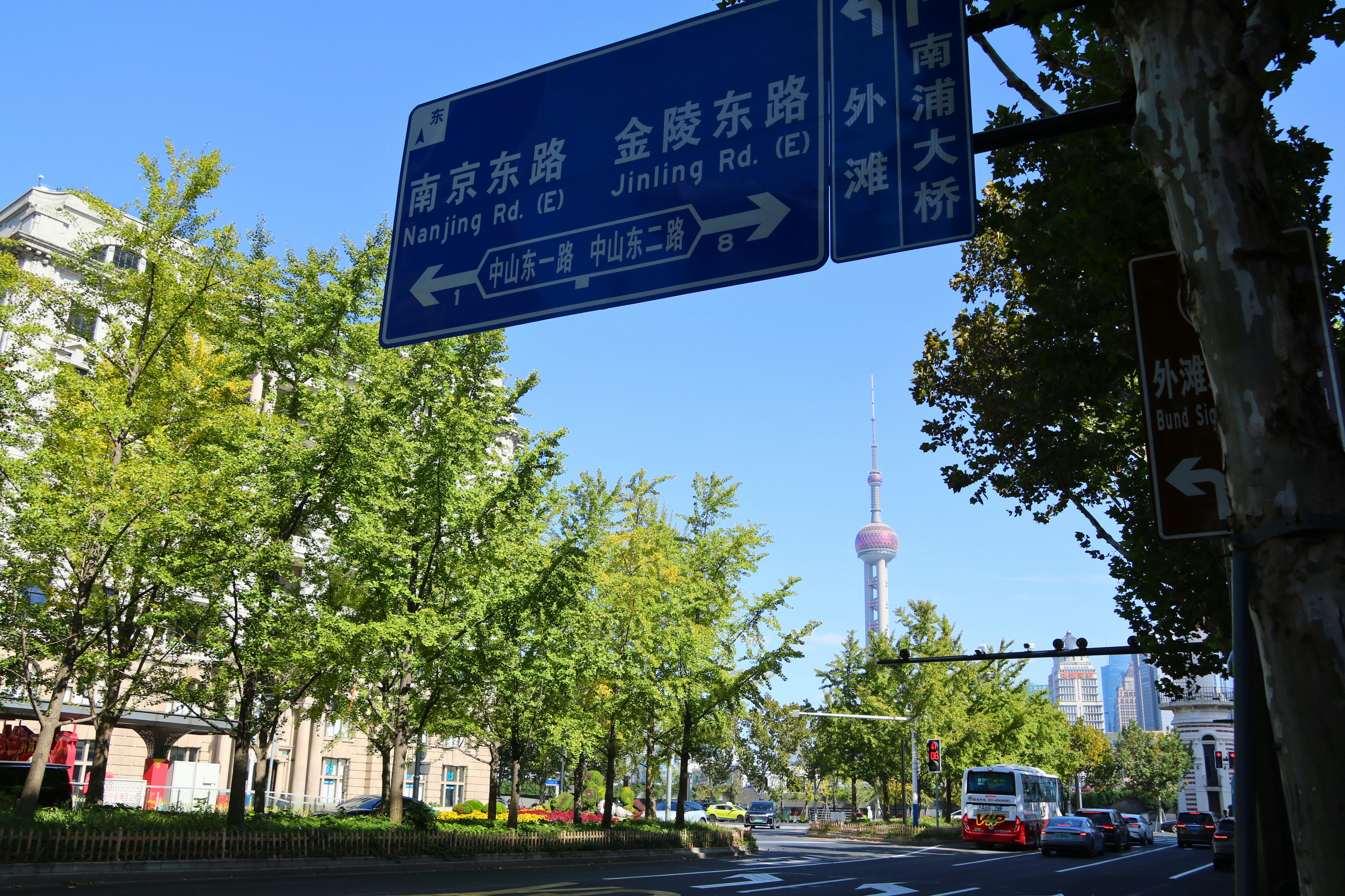 Street signs point towards jinling rd with tower in background photo ...