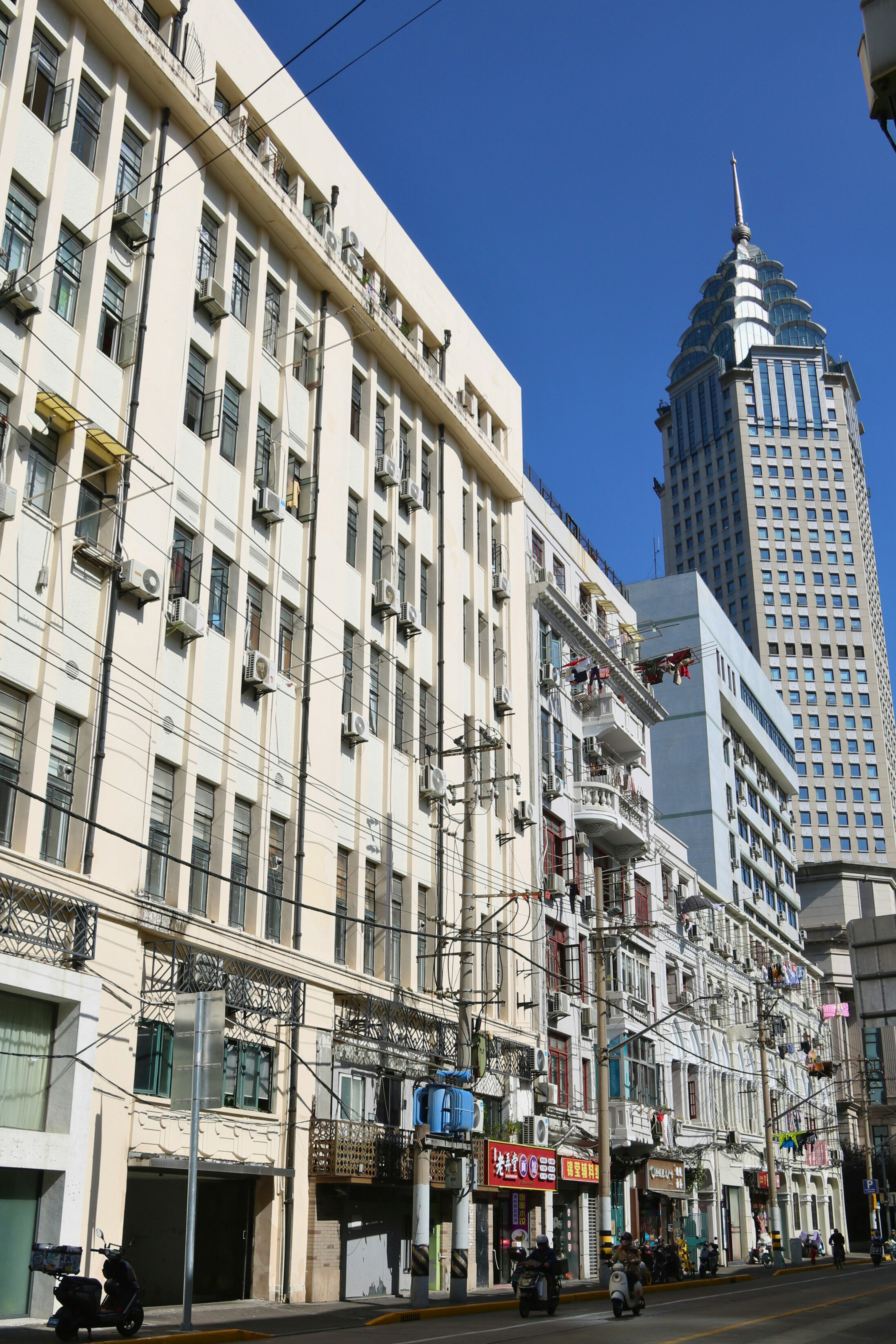Buildings line a street with a modern skyscraper behind. photo – Free ...