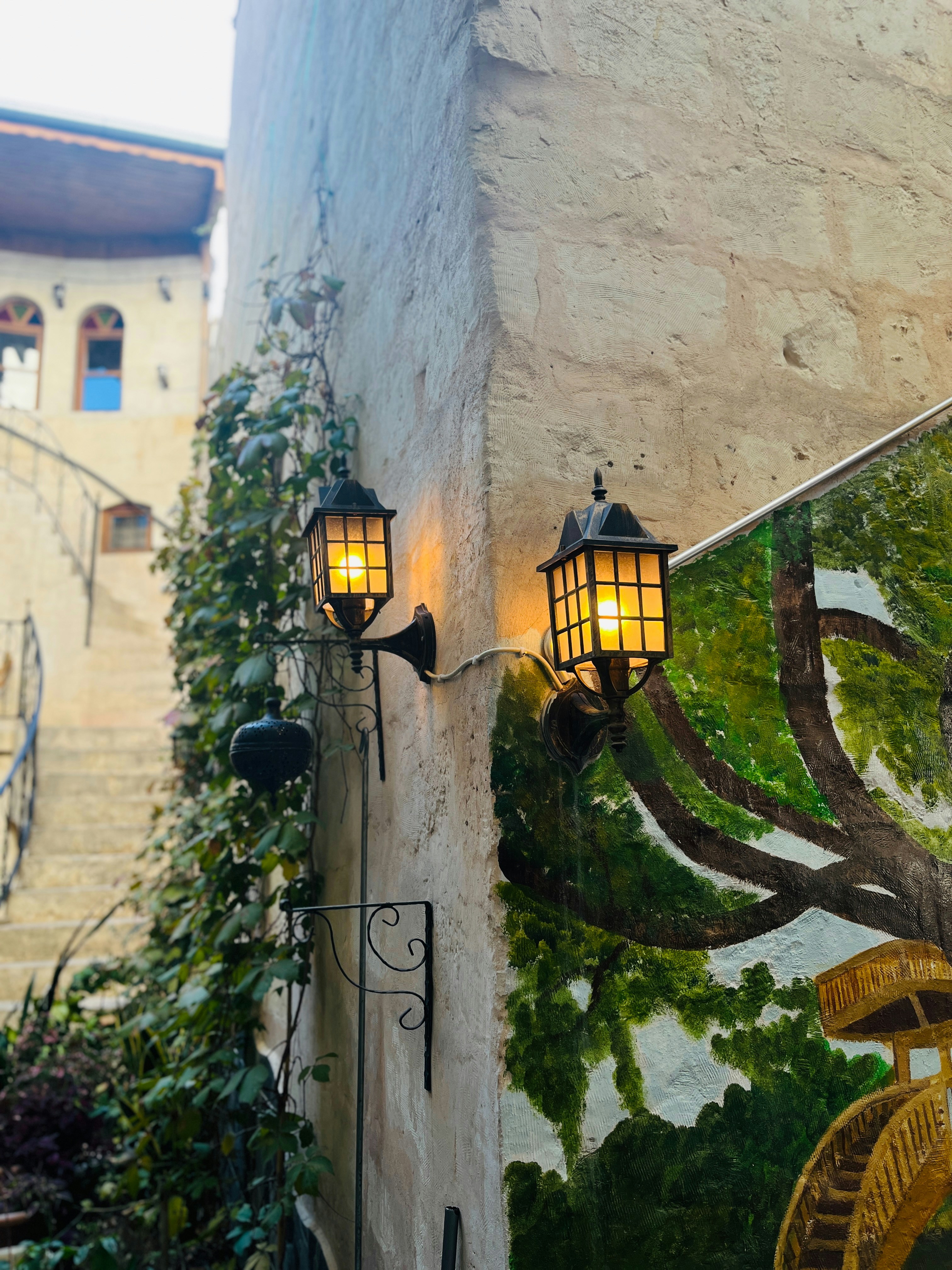 Lumen on the Wall: Lanterns Framing a Quiet Stairway