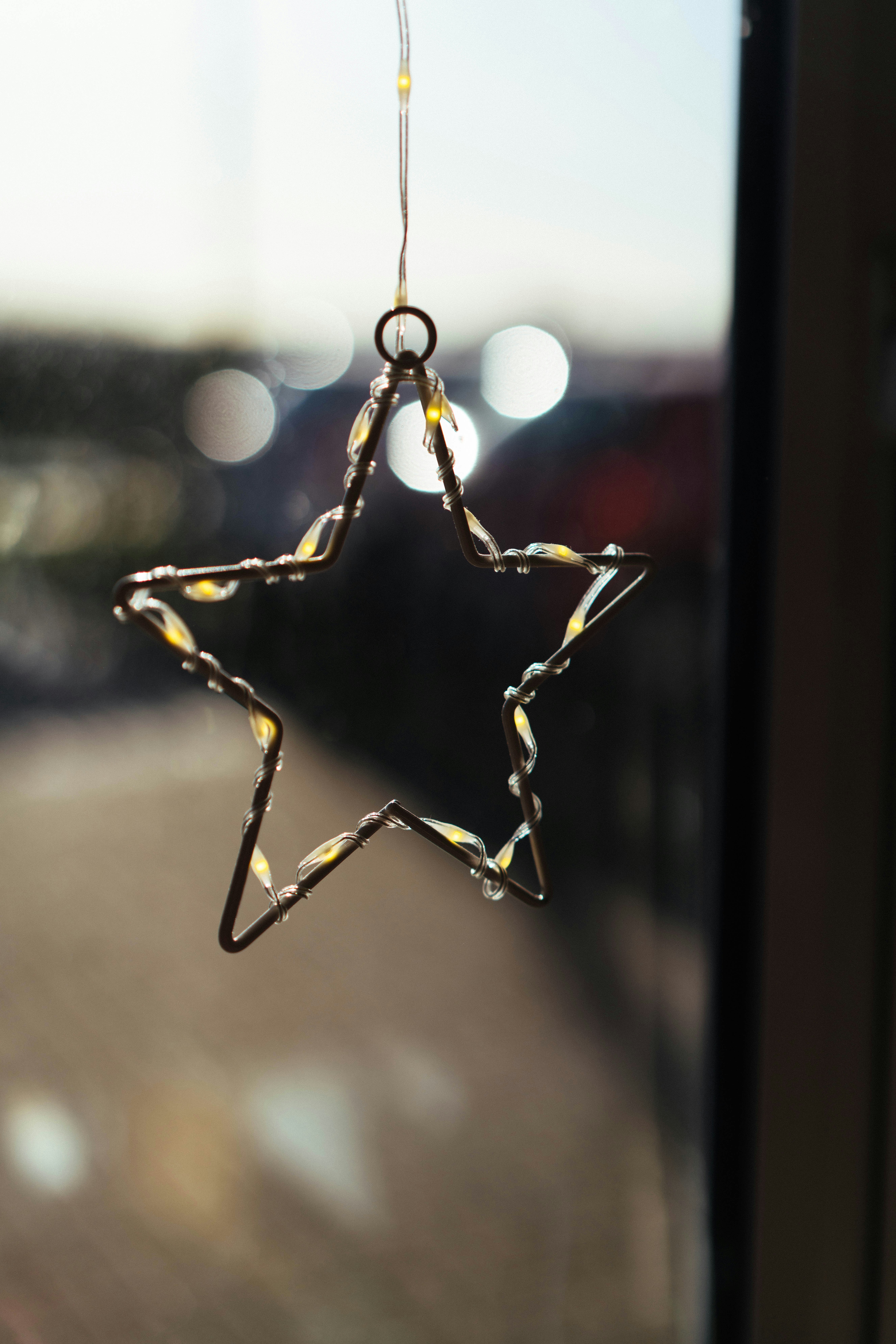 A Star of Warm Light: Hanging Miniature Lantern in Soft Backdrop