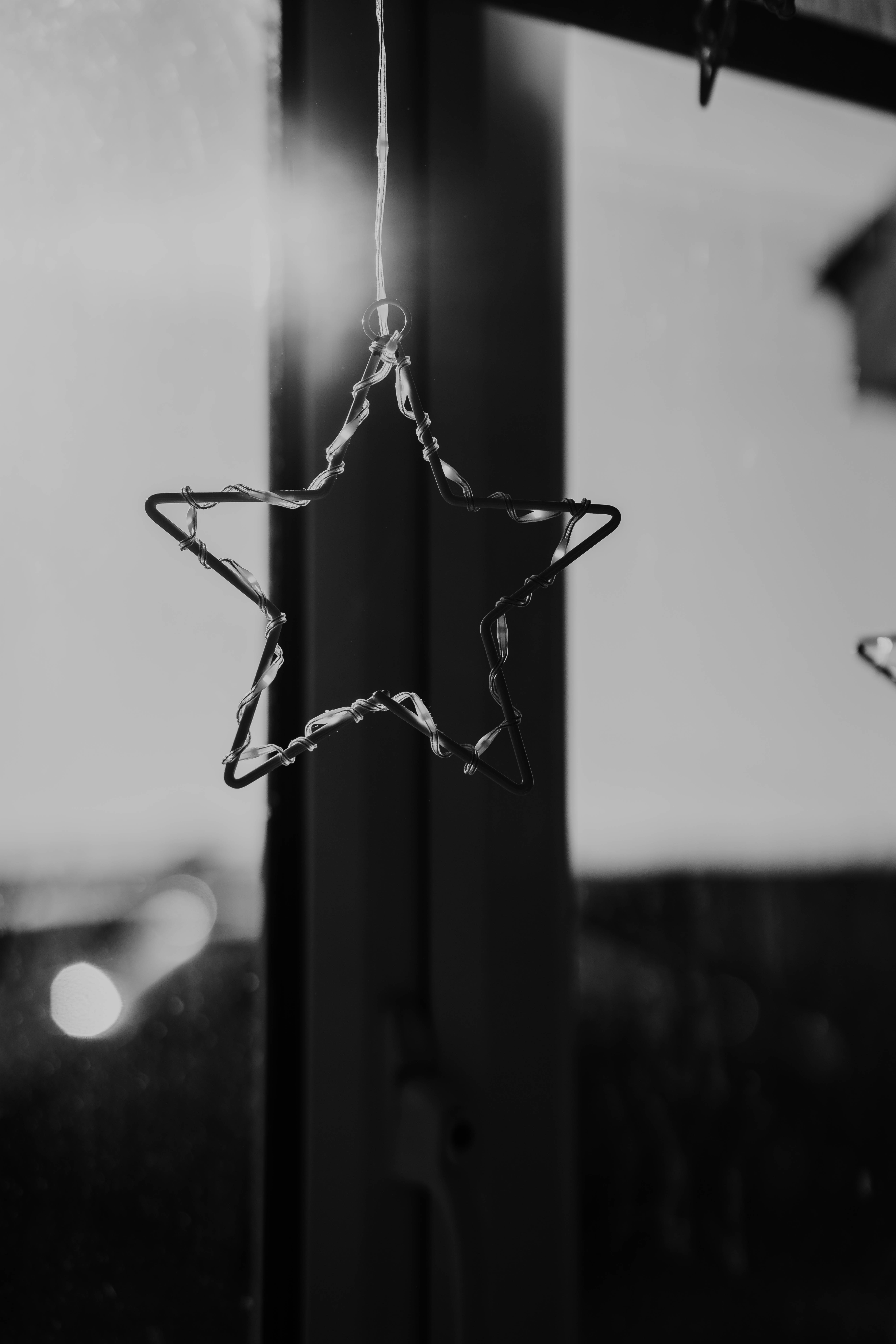 Hanging Star: a delicate wire frame against a sunlit window
