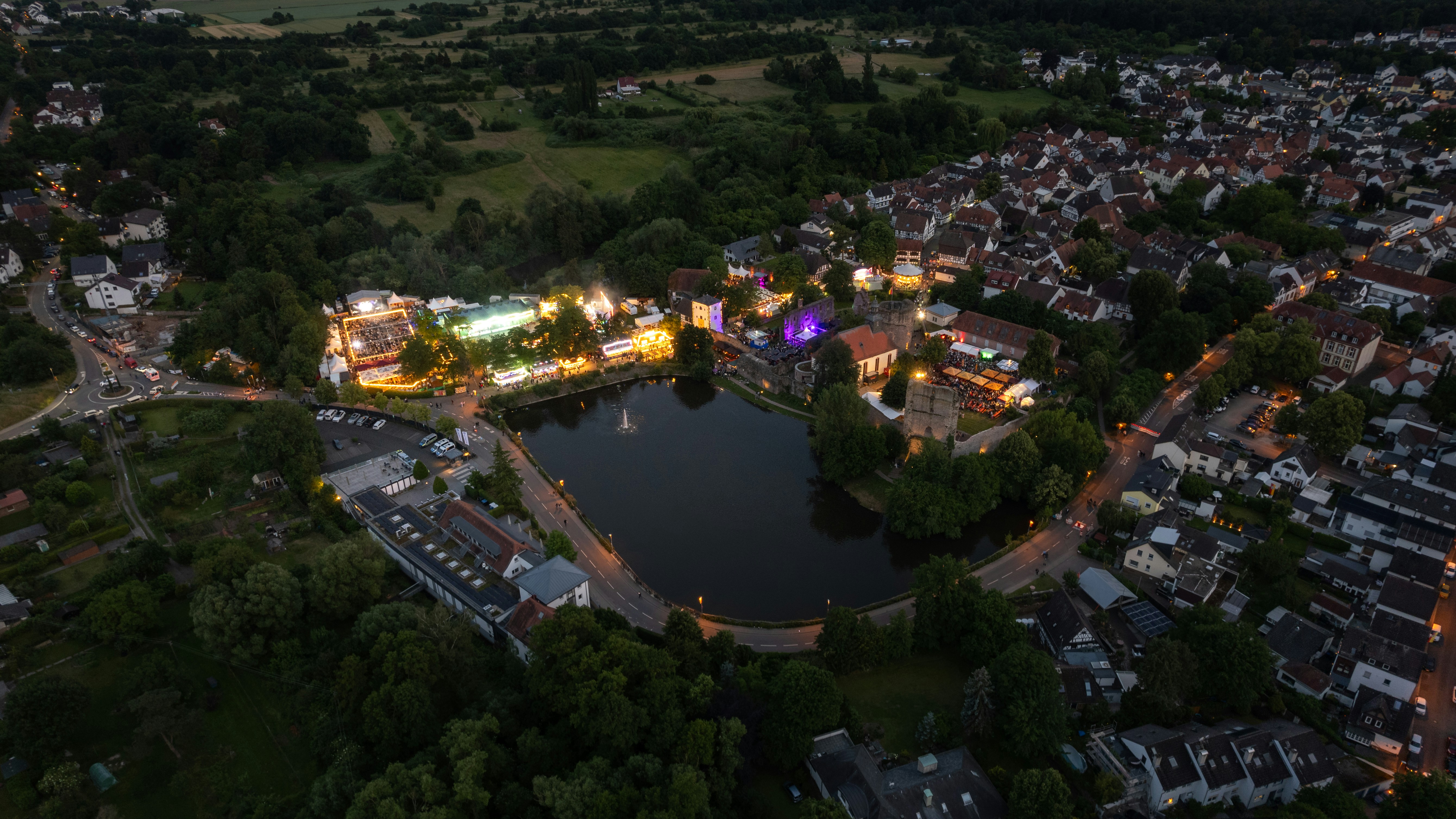 Lakeside Village at Dusk: Aerial Glow Over a Curved Waterfront
