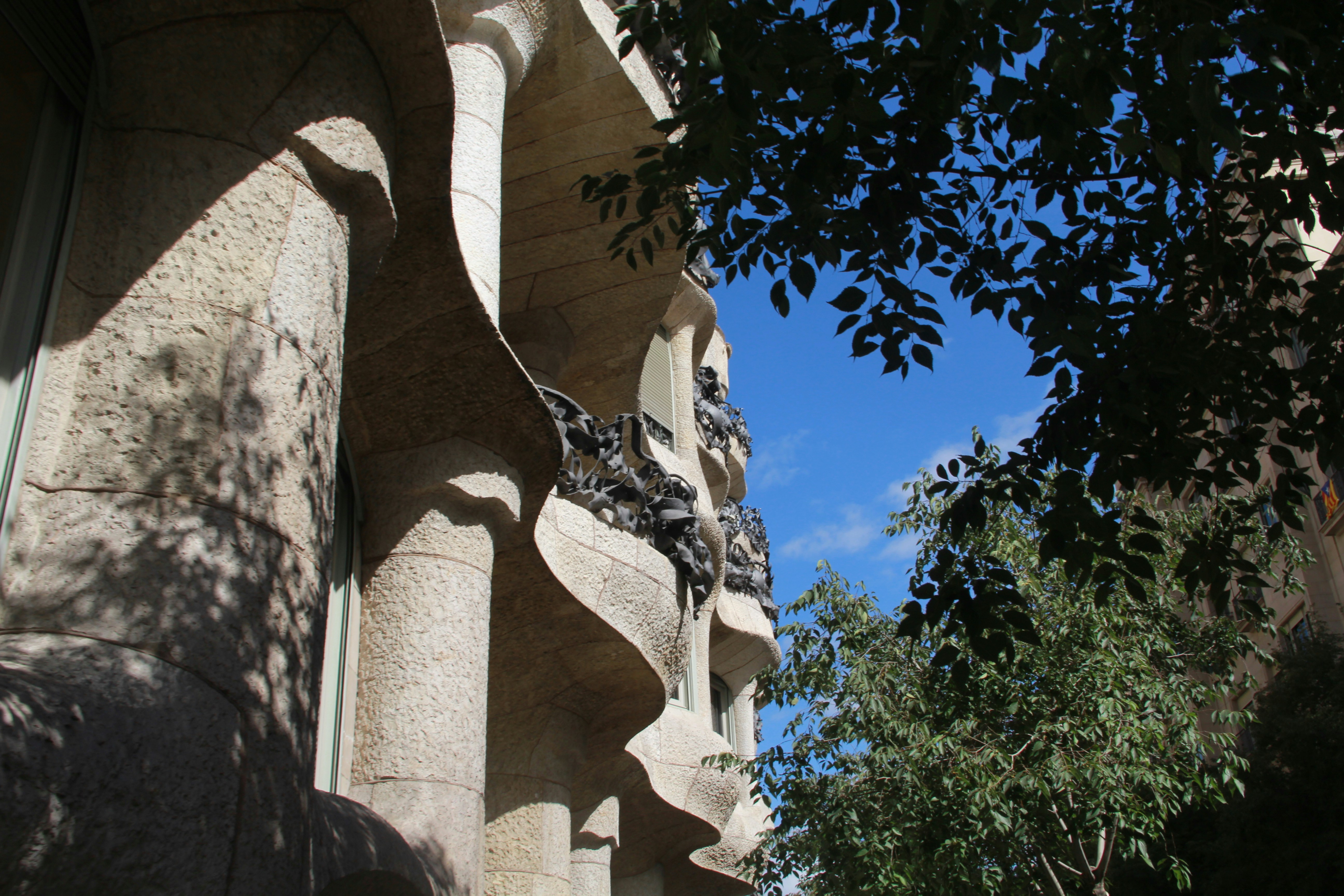 Stone Facade Echoes: Sculpted Architecture Reaching Toward a Blue Sky