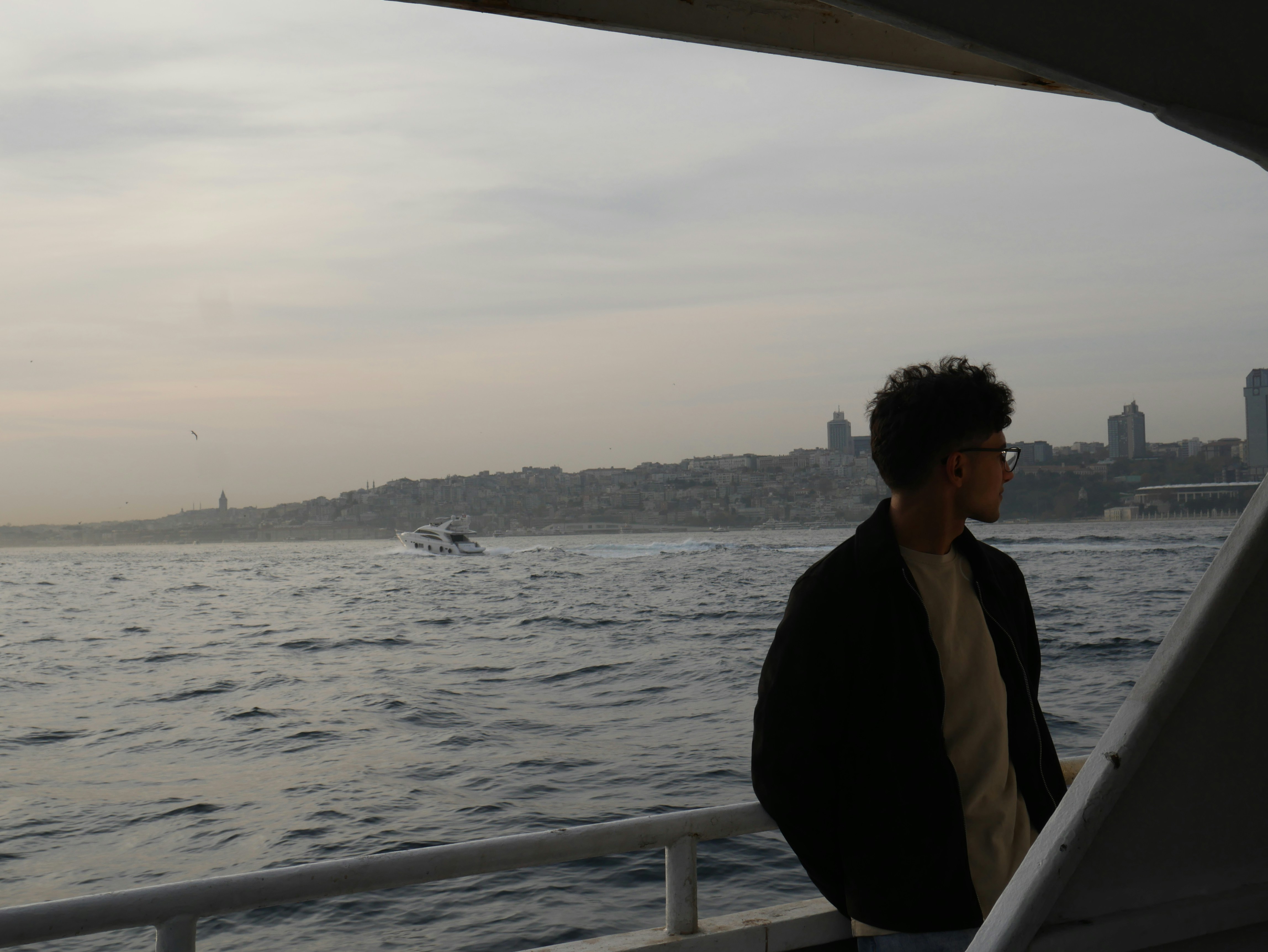 Rooftop Whispers: A Silhouette Against the Sea