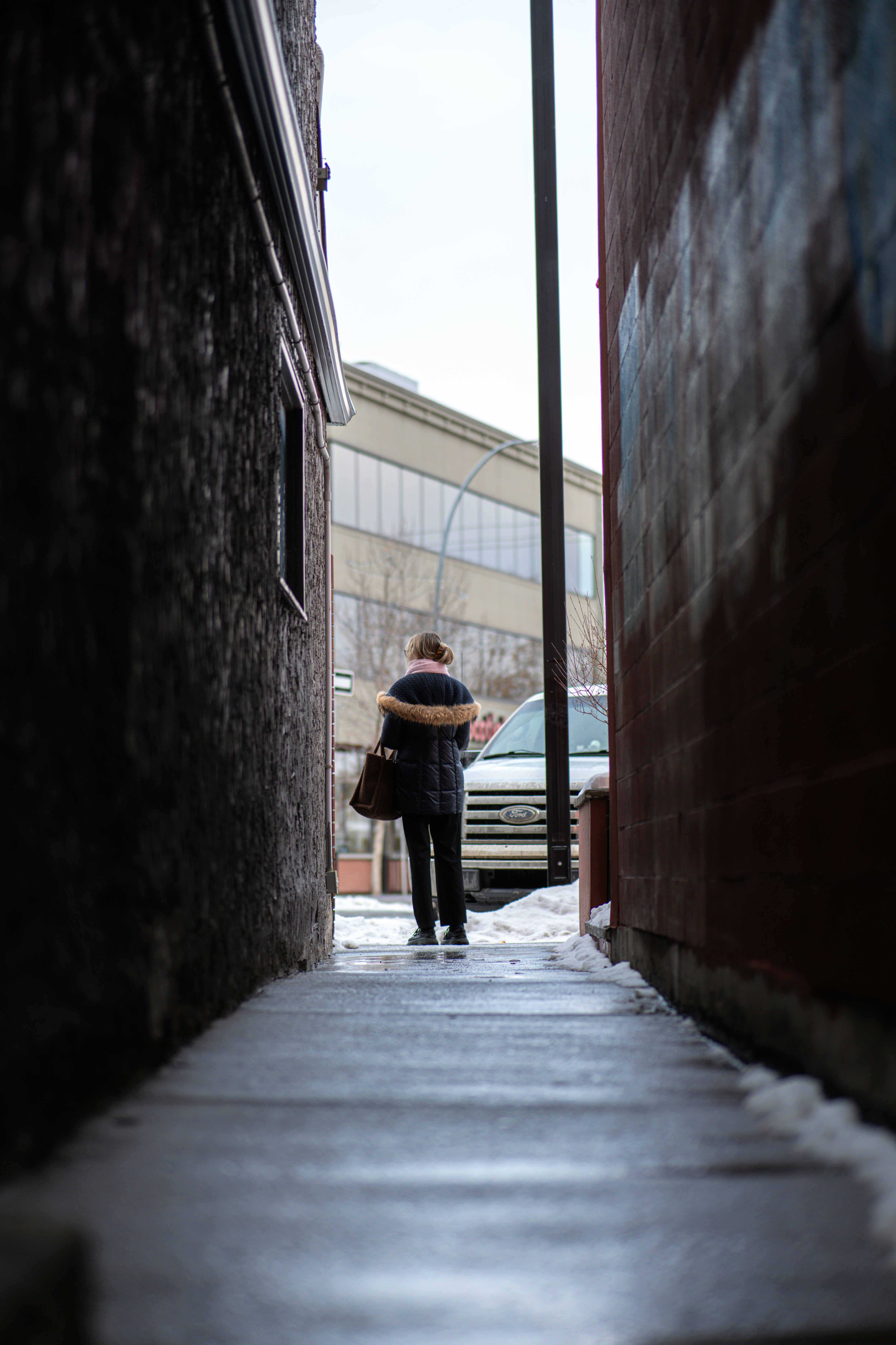 Winter Narrow: Quiet Pause with a Car at the End of the Alley