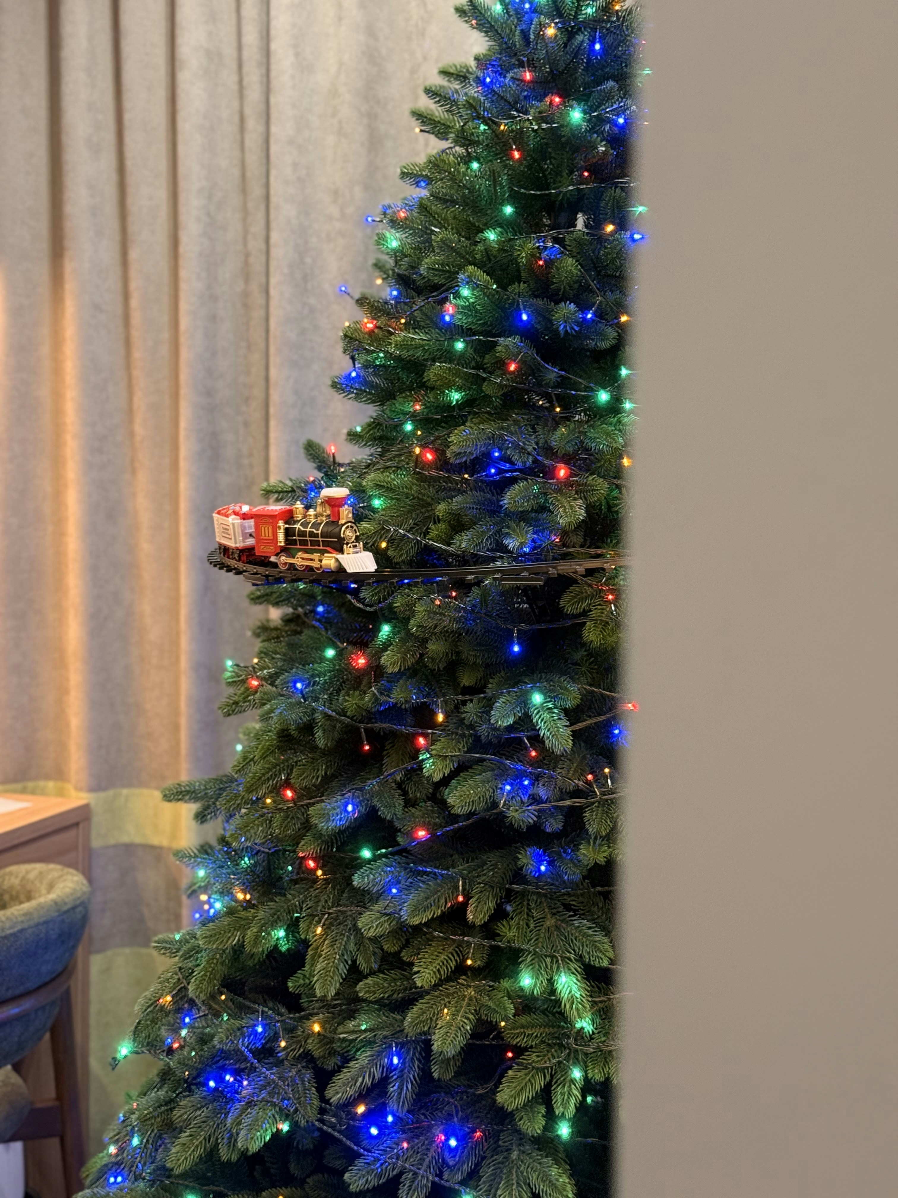 Tiny Train Wonder on a Glowing Christmas Tree