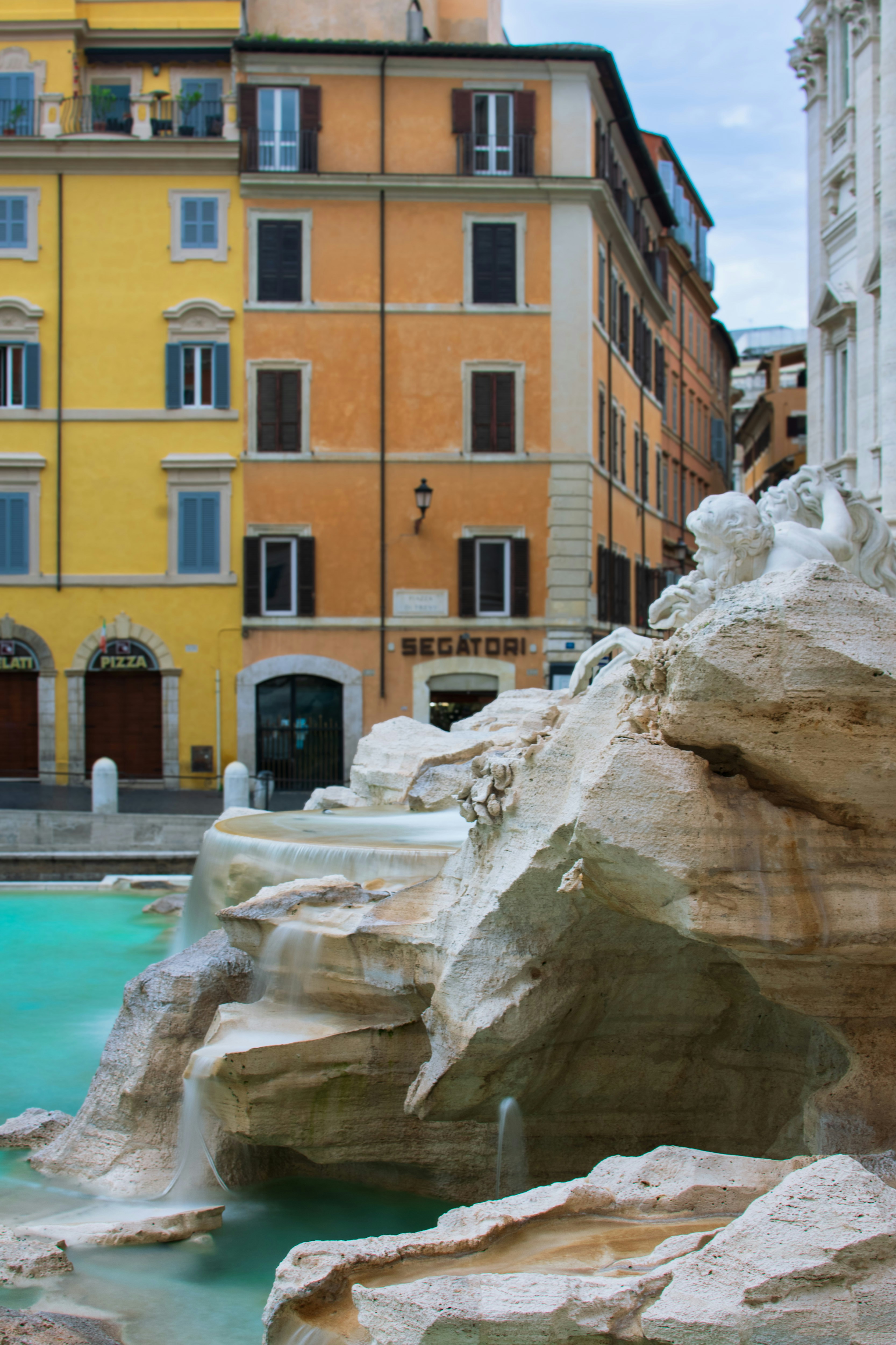 Sunlit Chiromantic Facades Overlooking a Turquoise Fountain