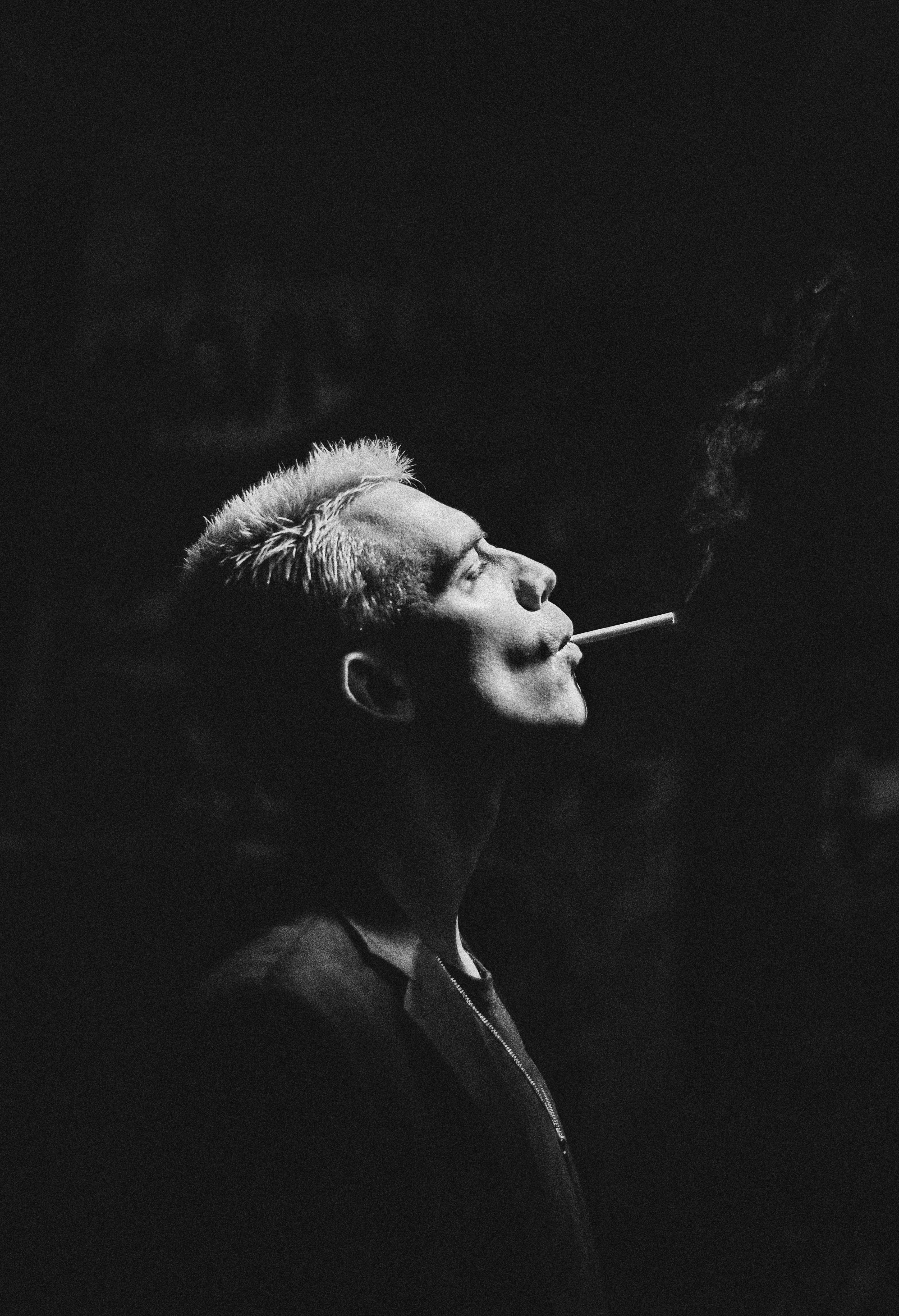 Smoke and Spotlight: A Portrait in Shadow