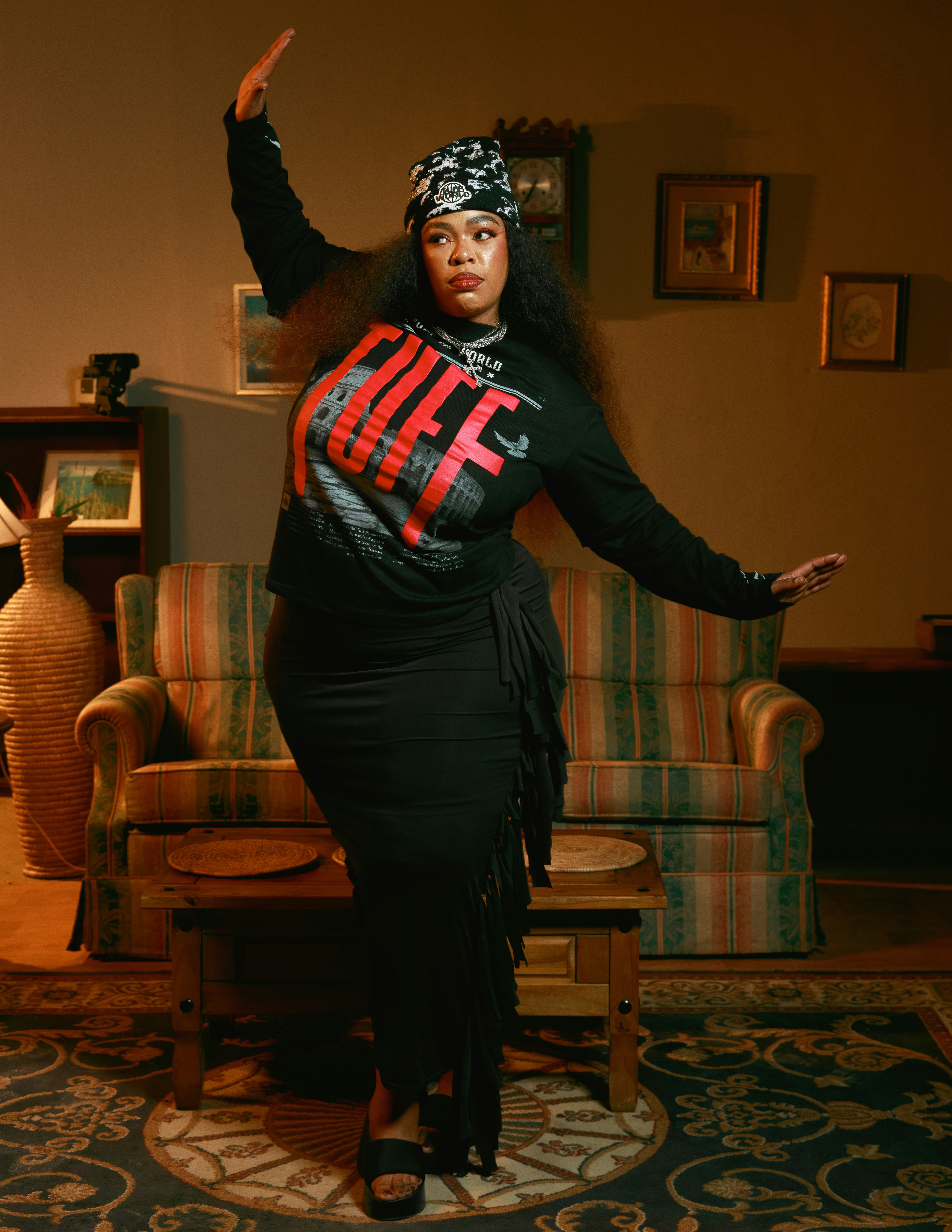 Bold Dancer in a Warm Living Room: A Portrait in Black Onyx and Red Script