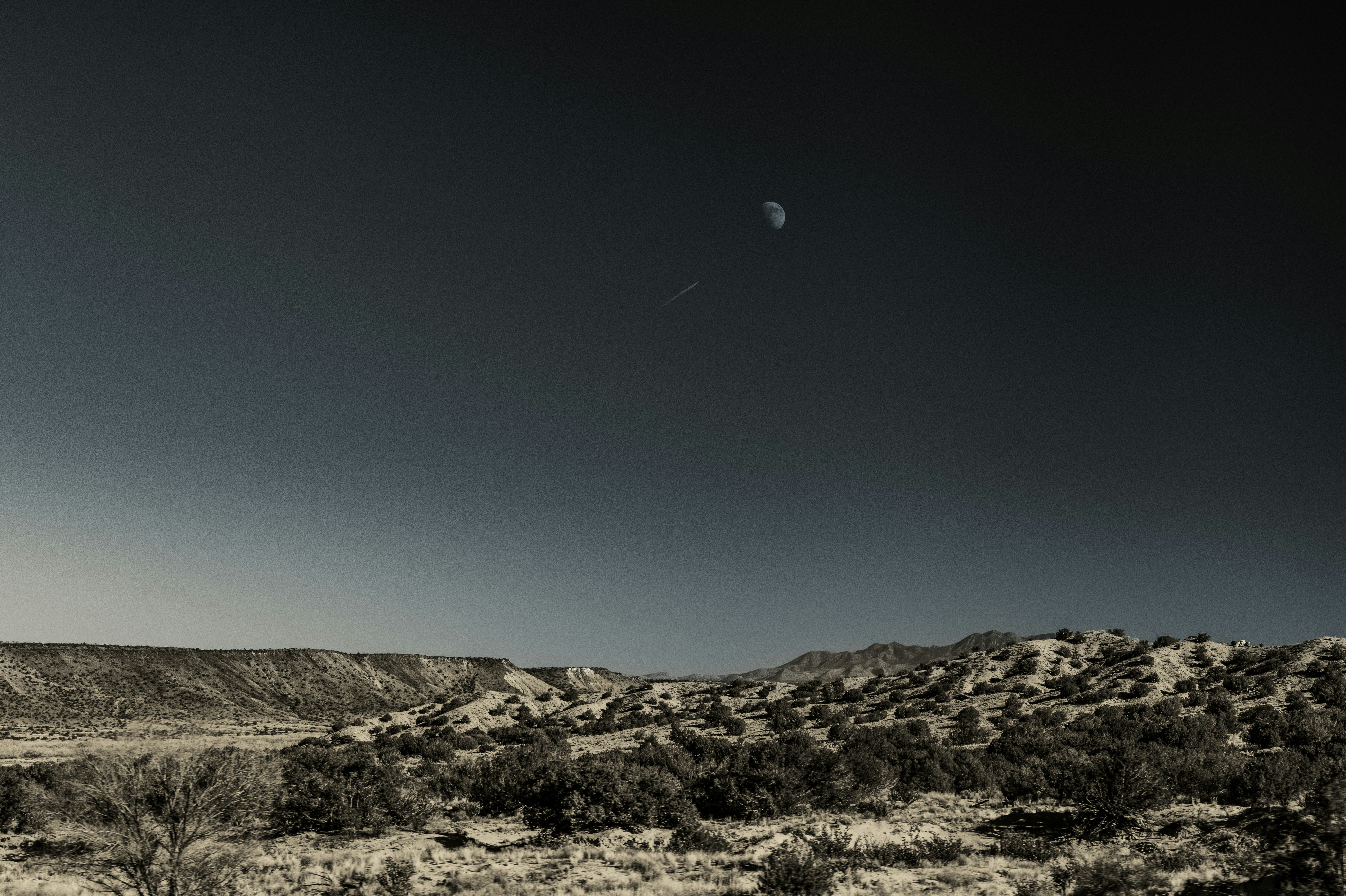 Desert Rim Under a Distant Moon