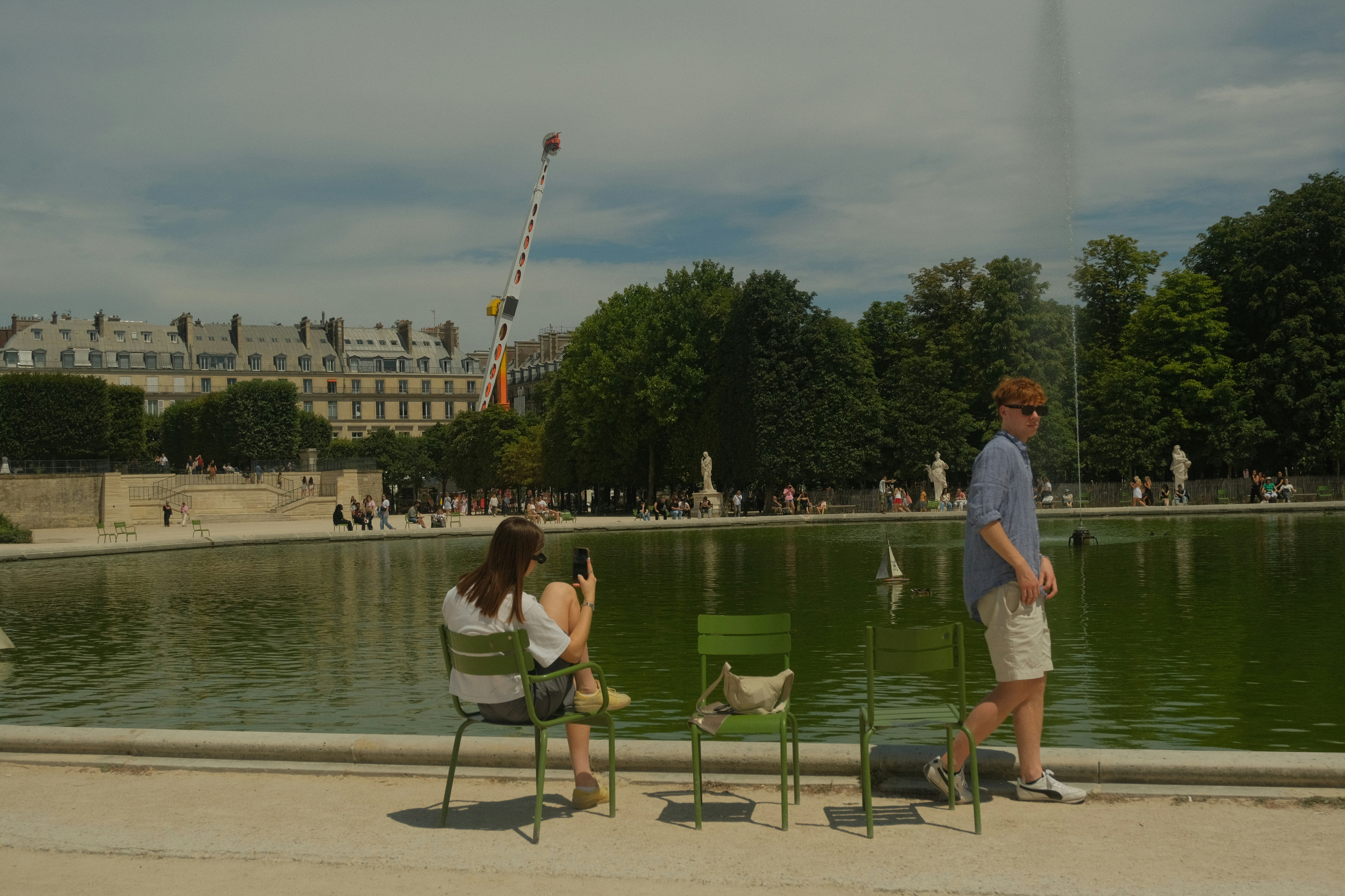 A Quiet Moment by the Tuileries Pond: Stranger, Chairs, and Afternoon Light