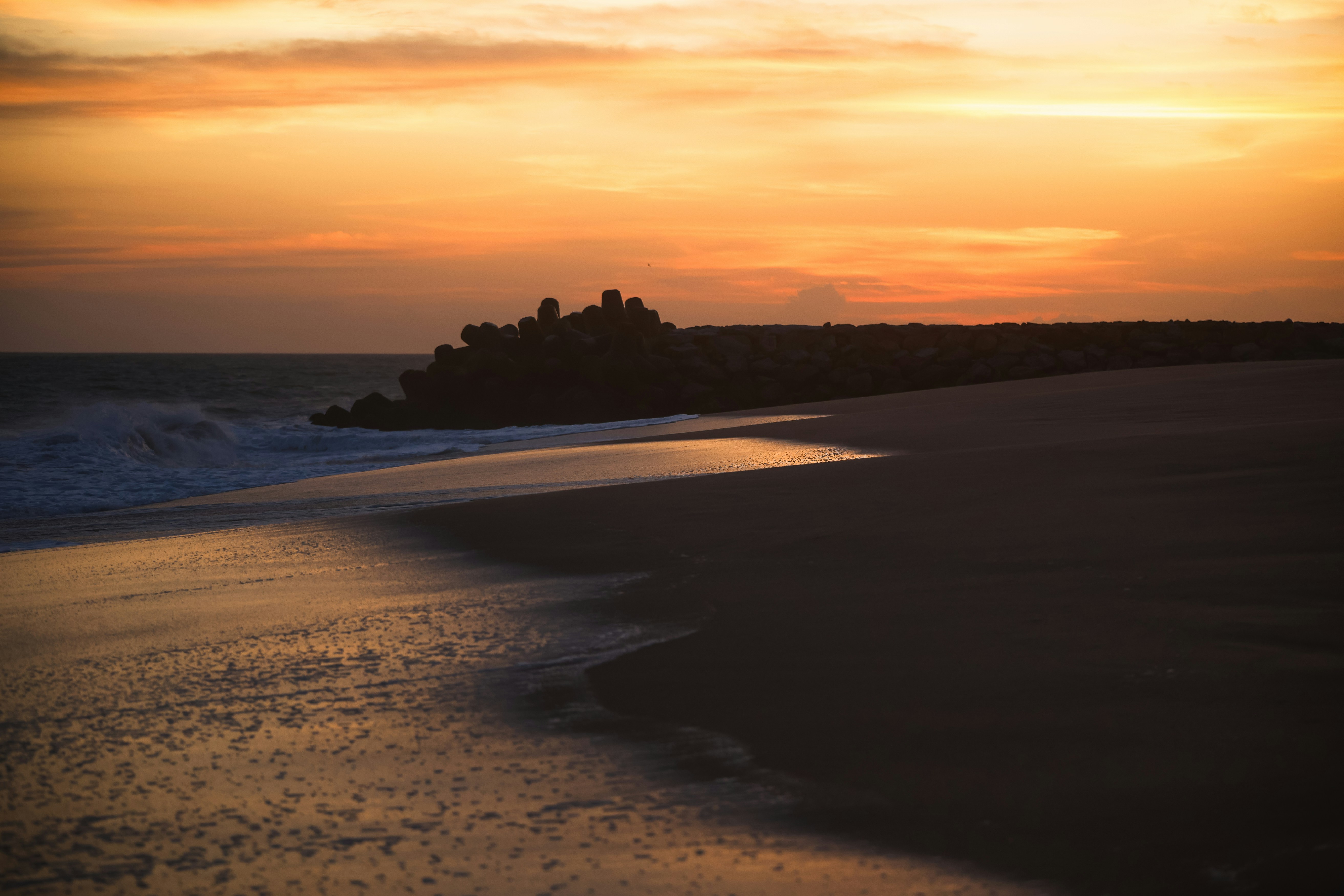 Dusk Over the Breakwater: Quiet Shoreline at Sundown