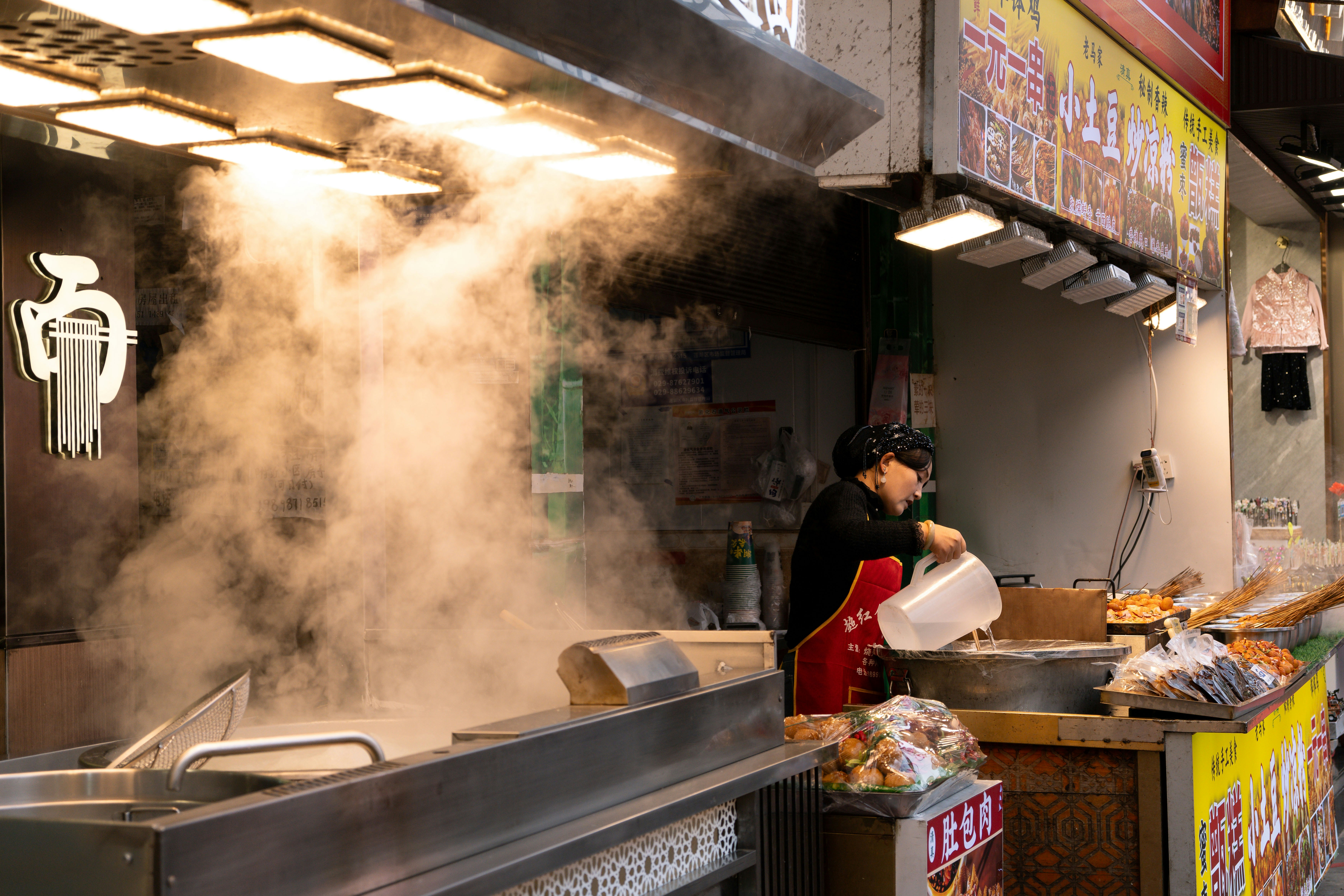 A Vender cooking street food, Muslim Quarter, Xian, China