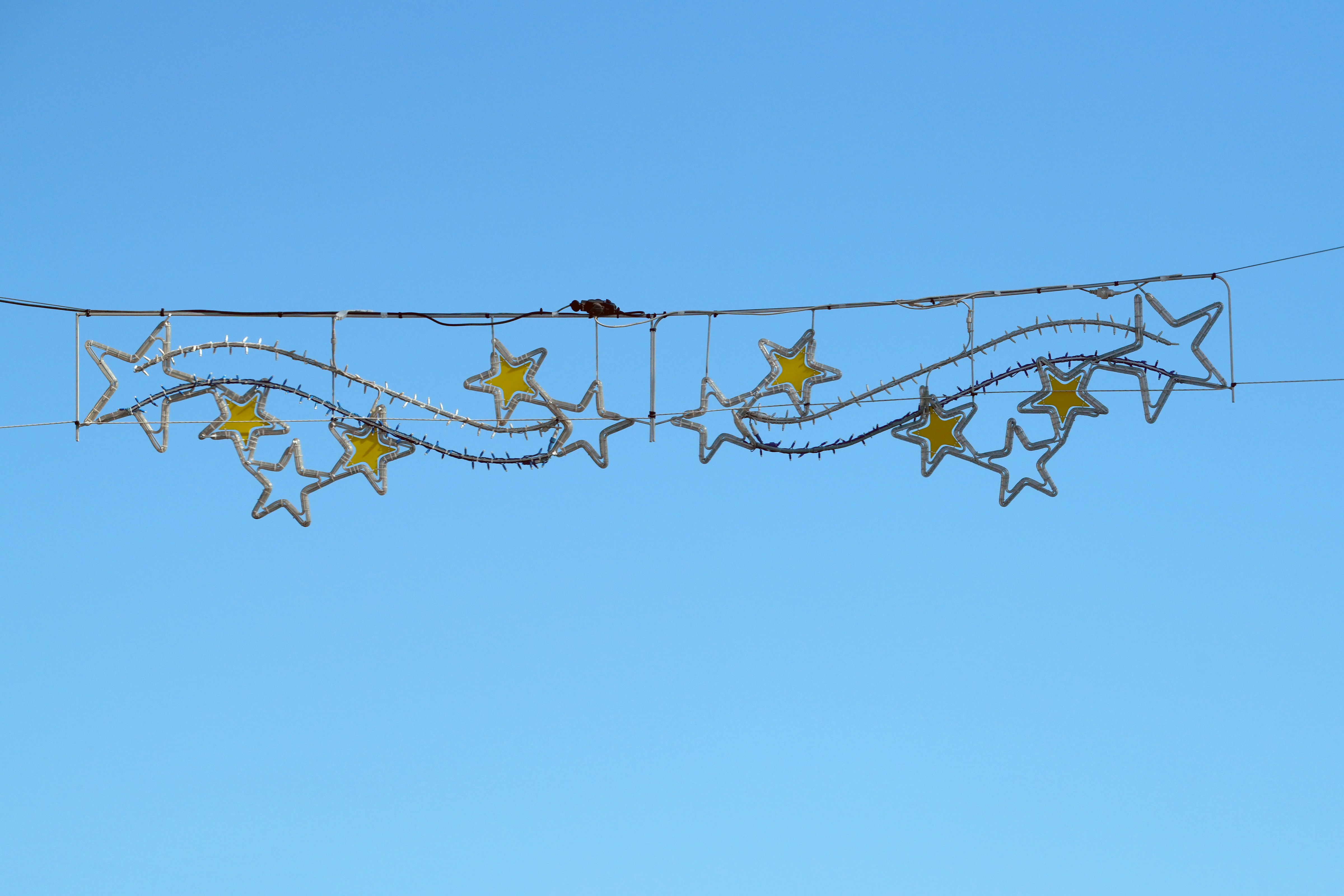 Midwinter Star Garland Draped Against Clear Sky