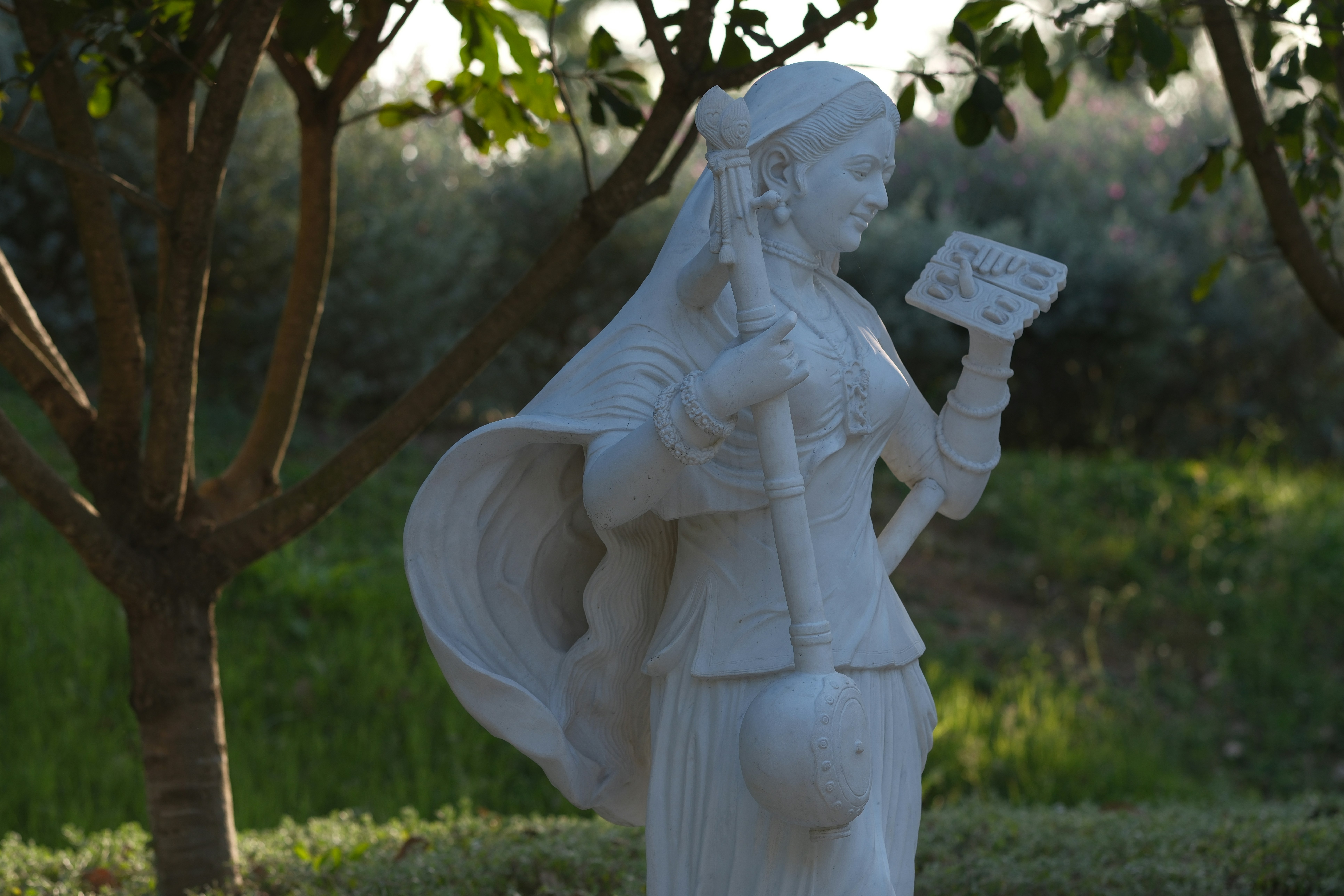 Graceful Marble Guardian in Dappled Garden Light