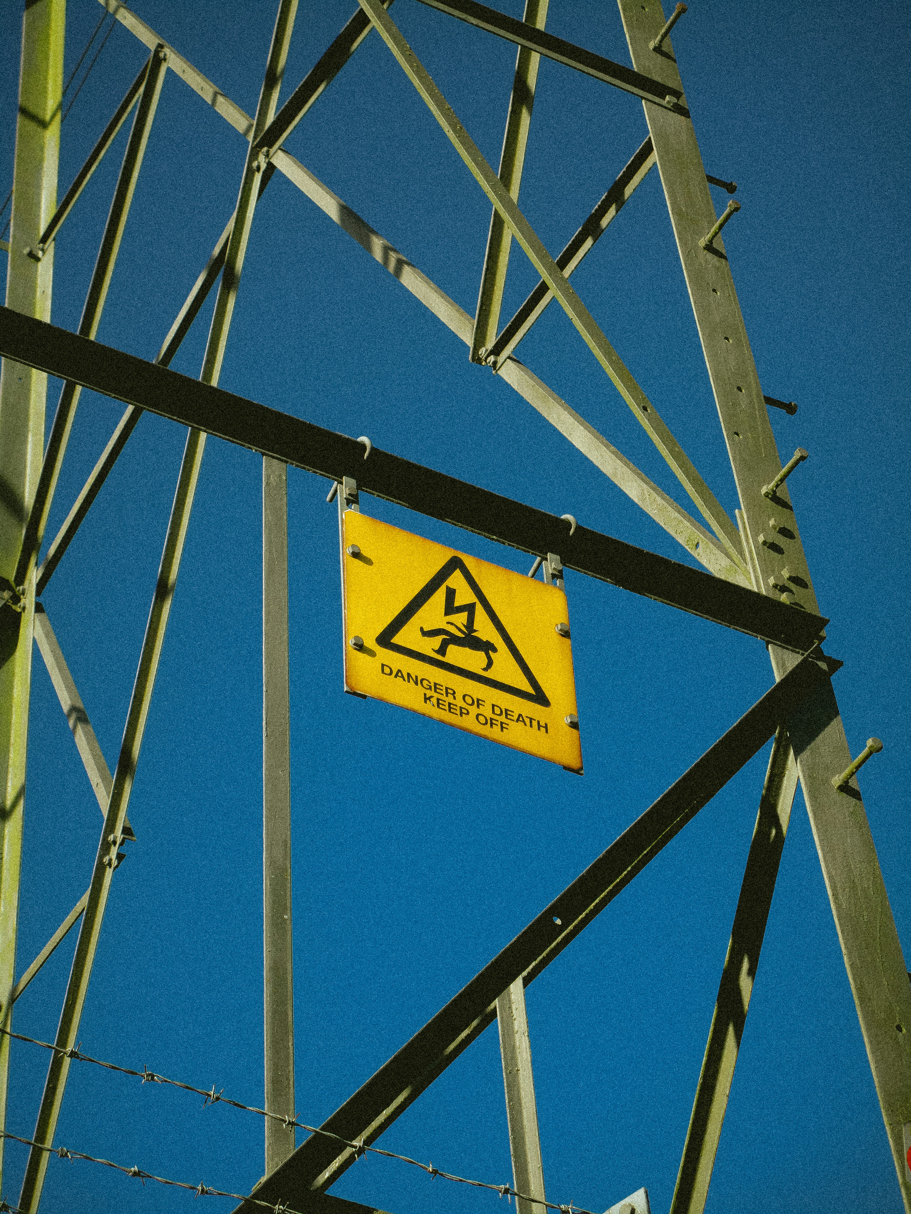 Danger Sign Against a Sky of Steel