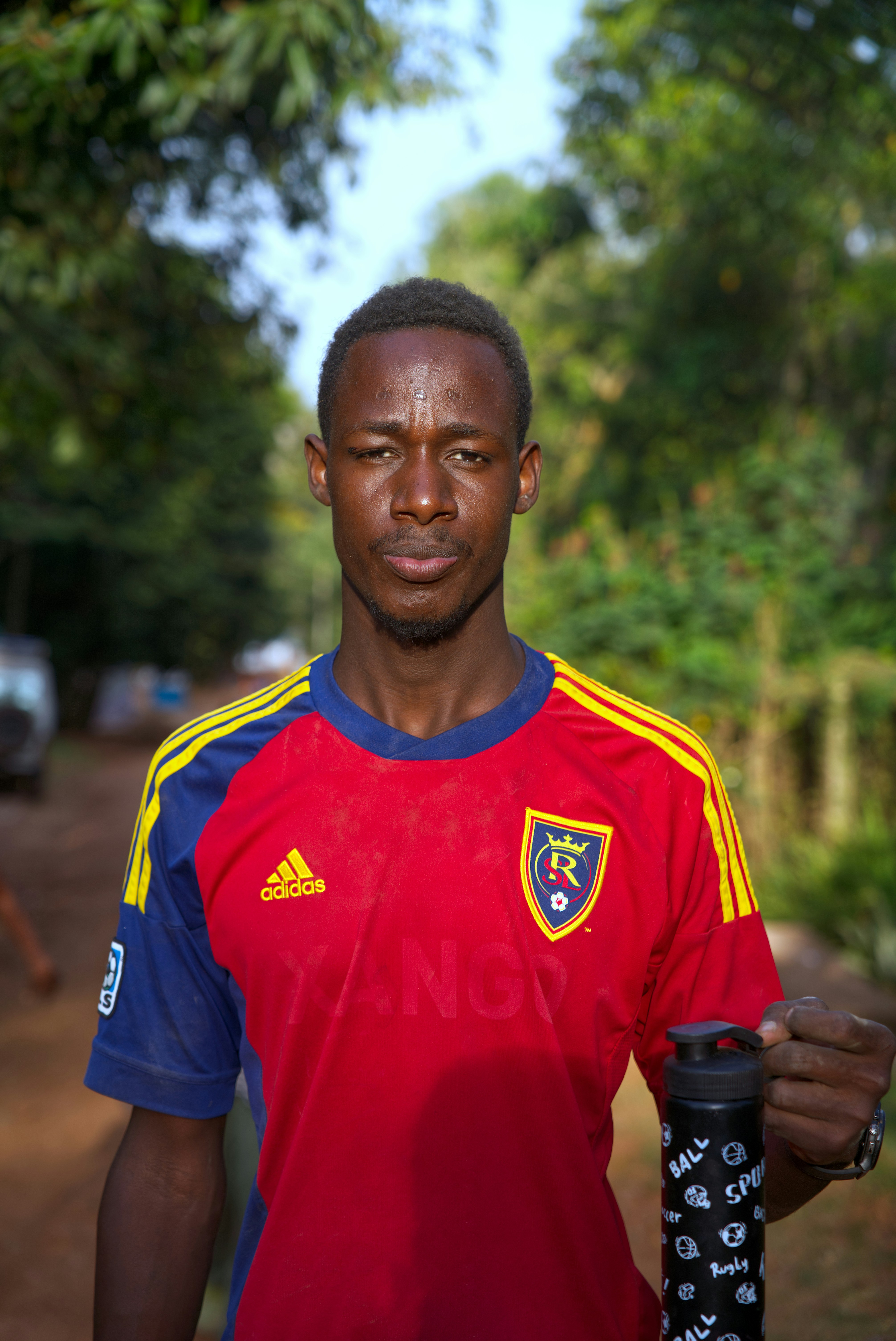 Portrait in the Park: Focused Gaze with a Royal Red Jersey