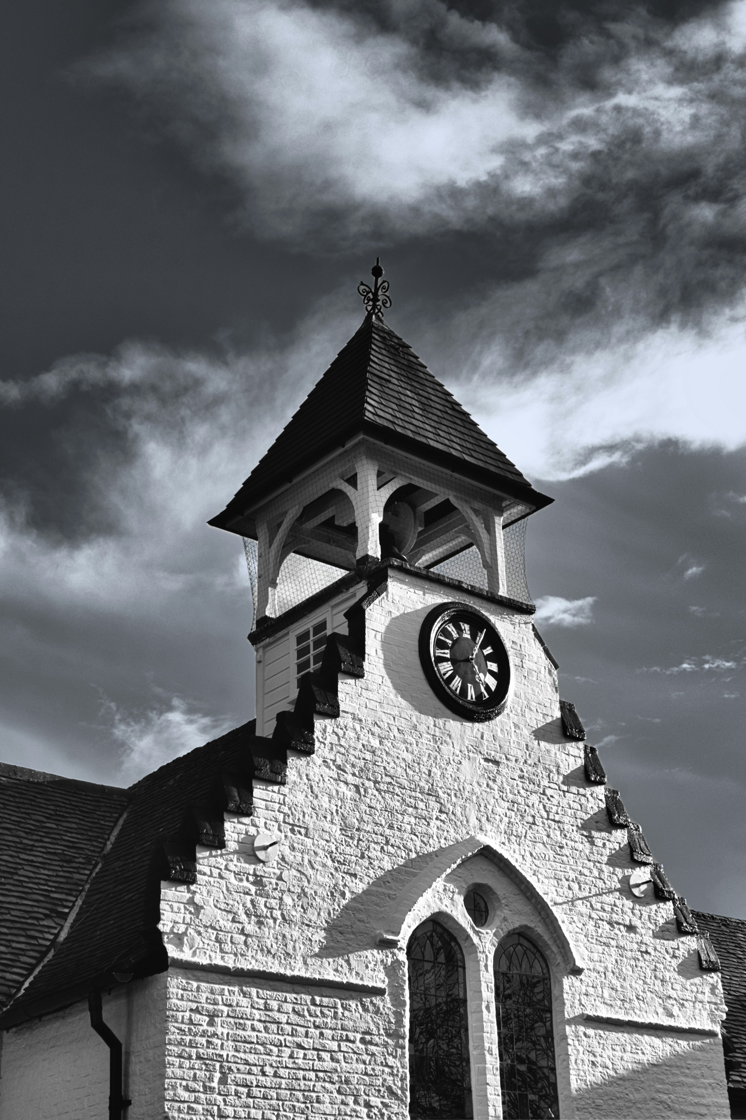 Sculpted Time: A Stone Clocktower Under Stormy Skies
