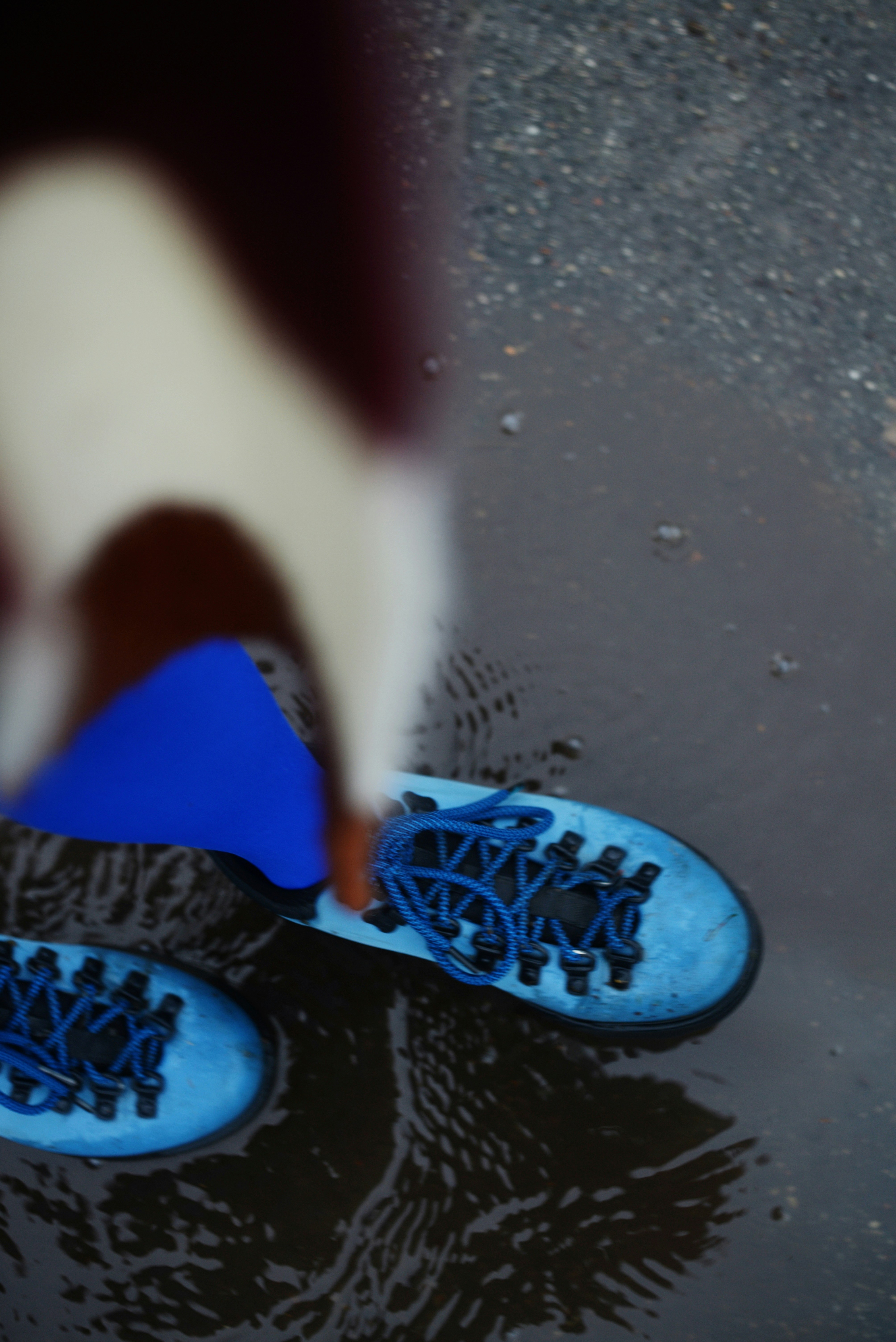 Vibrant Blue Boots on a Wet Street