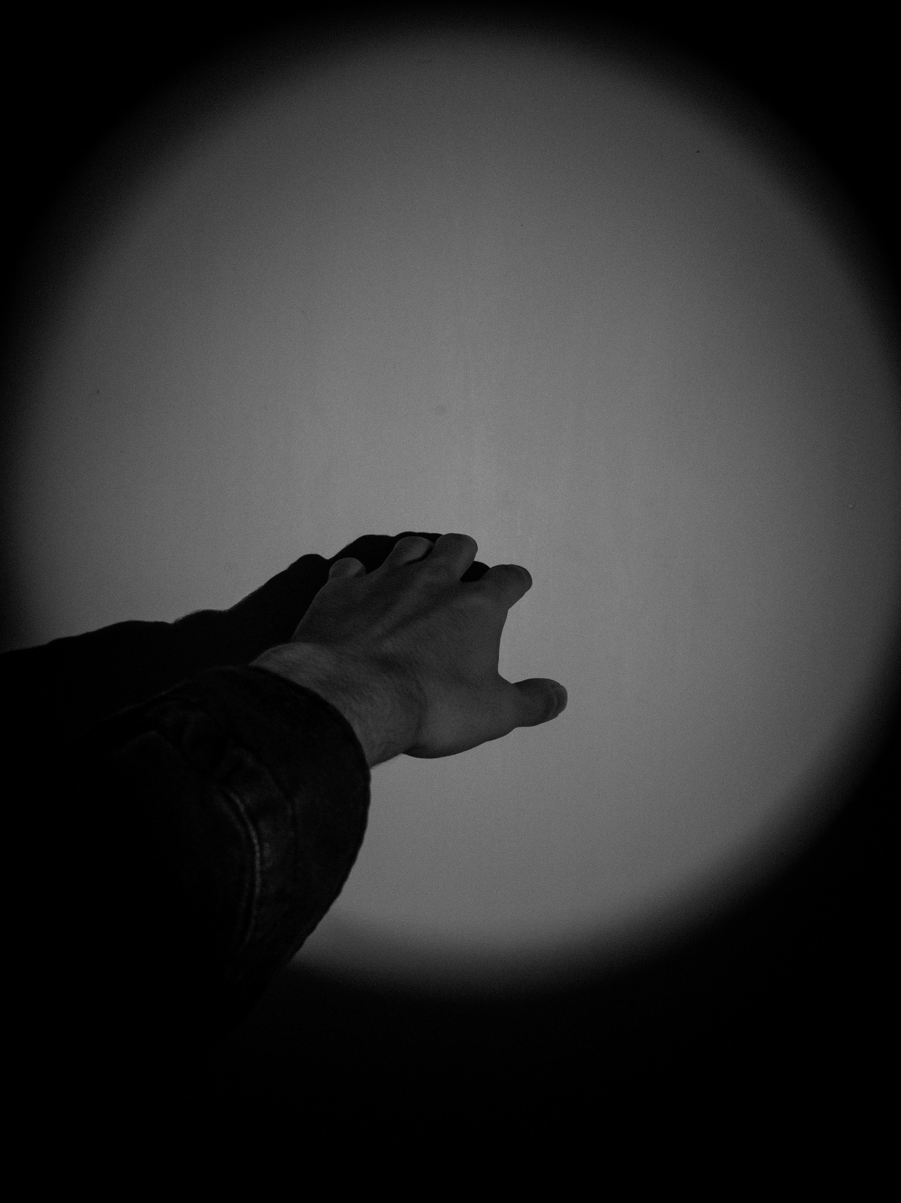 A hand reaching out in darkness