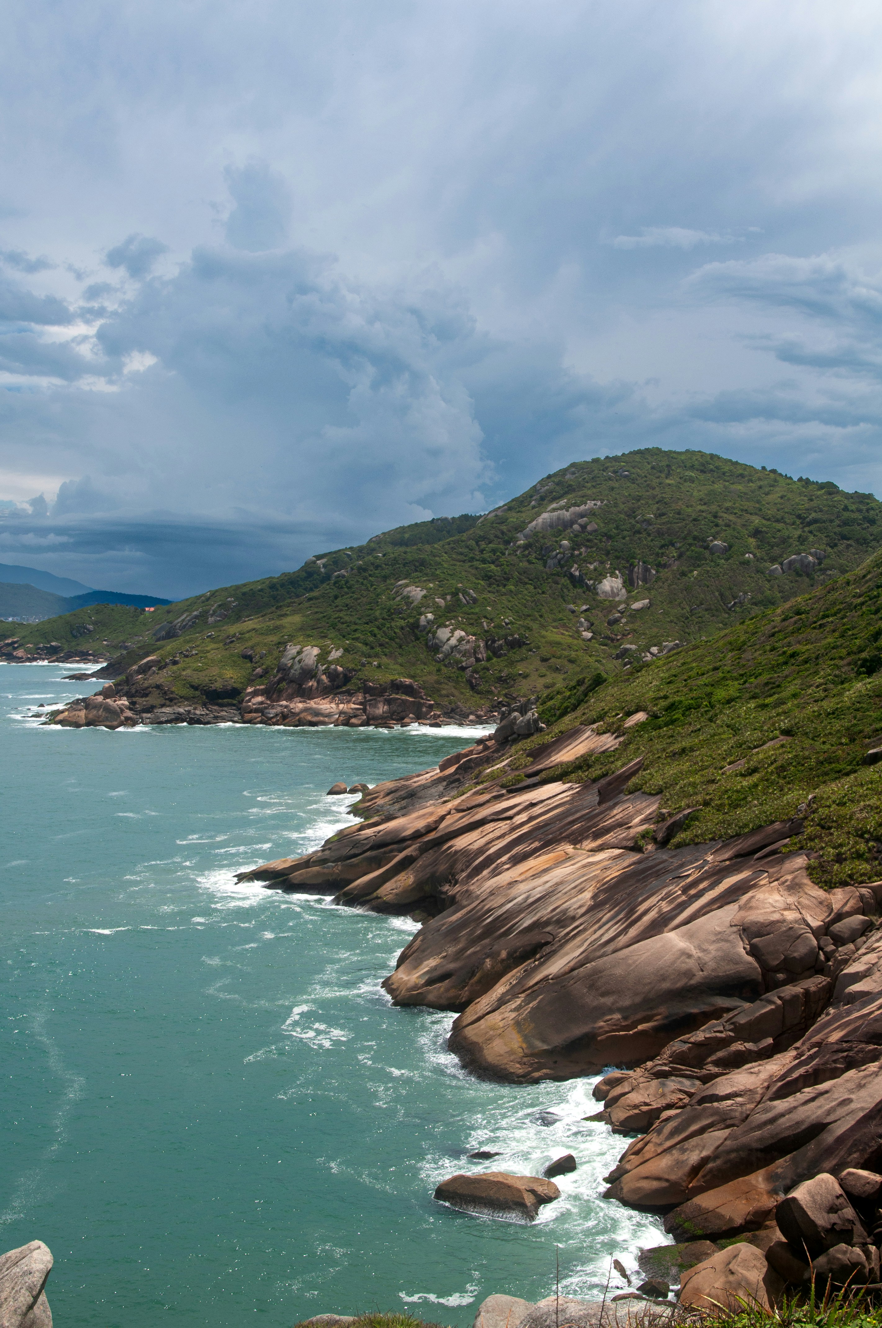 Coastal RidgesCatch: Green Hills Meet Turquoise Sea along Rugged Granite Coast