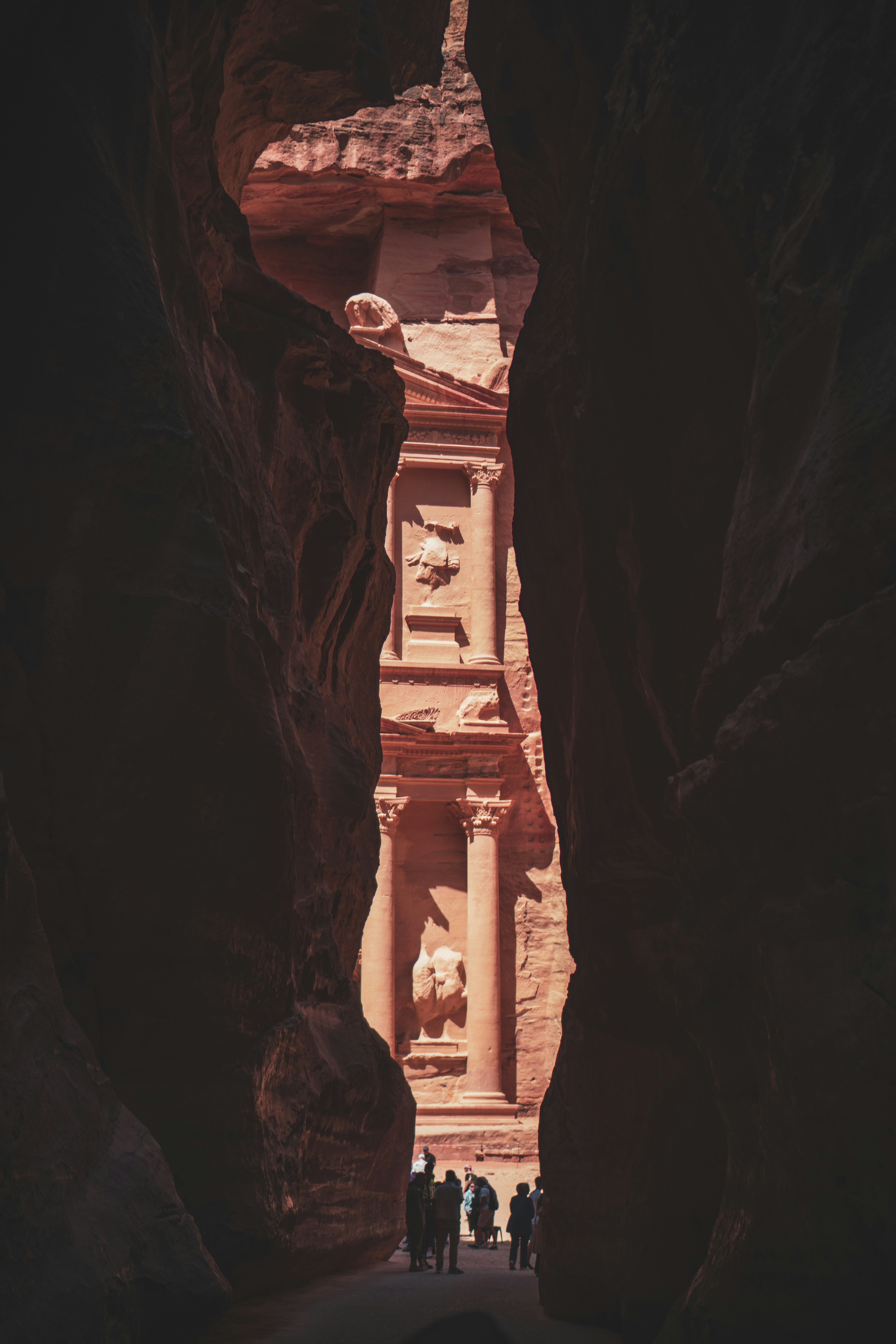 Between the Narrows: Carved Facade Peeking Through a Canyon Gap