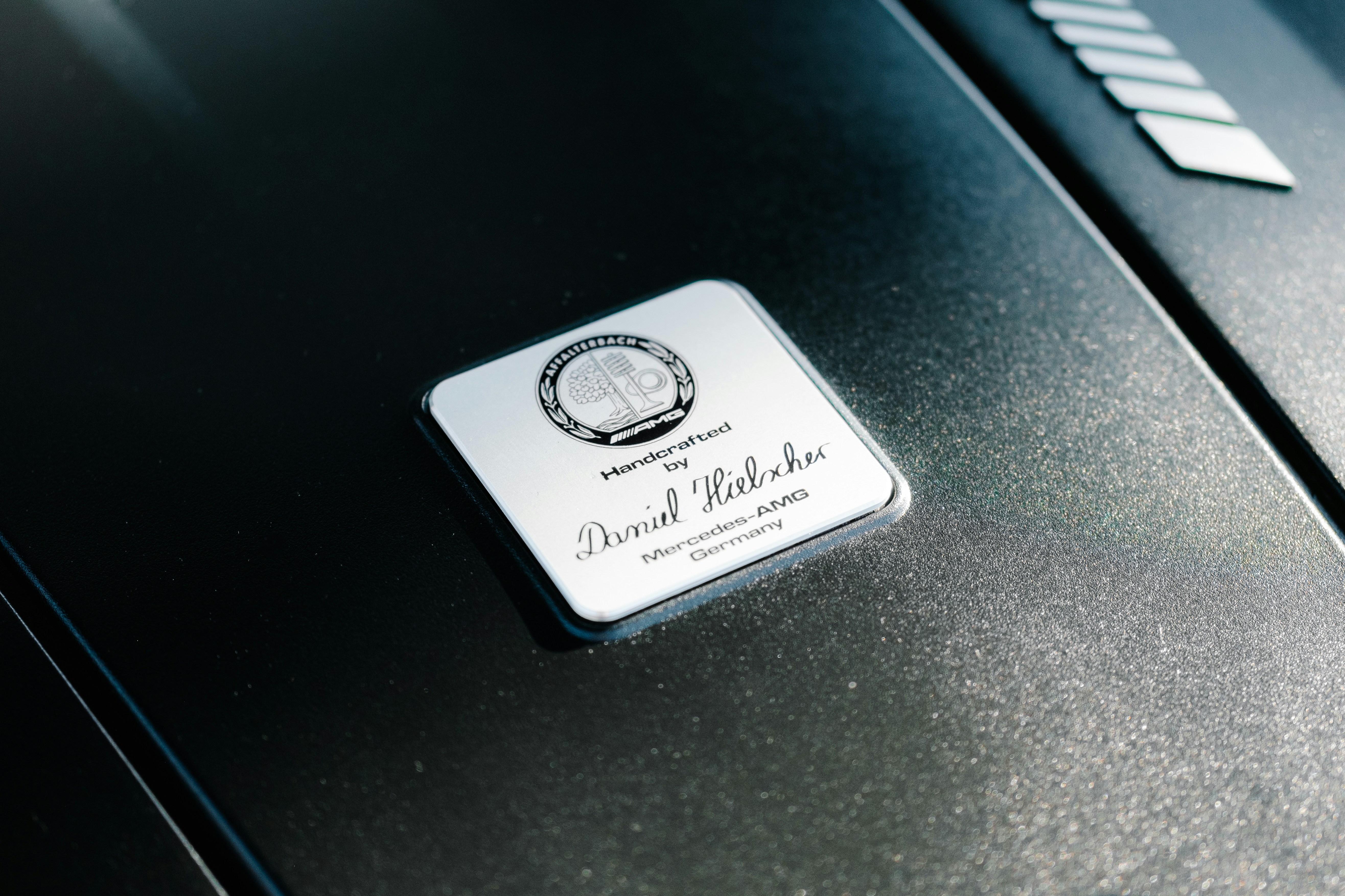 Signature Tile: A Close-Up of the Brand Stamp on a Metallic Surface