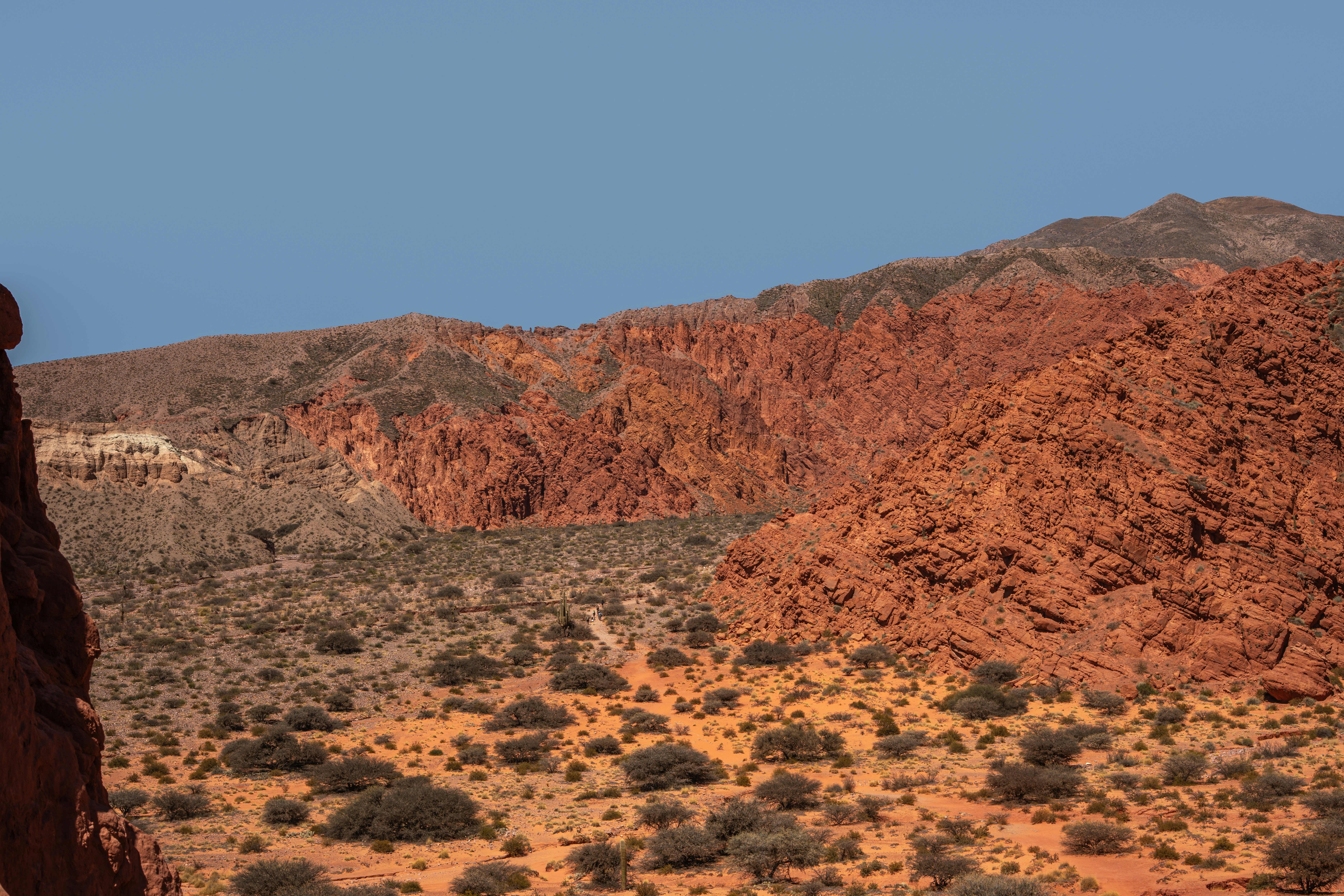 Rugged Red Ridge Beyond the Desert Plain