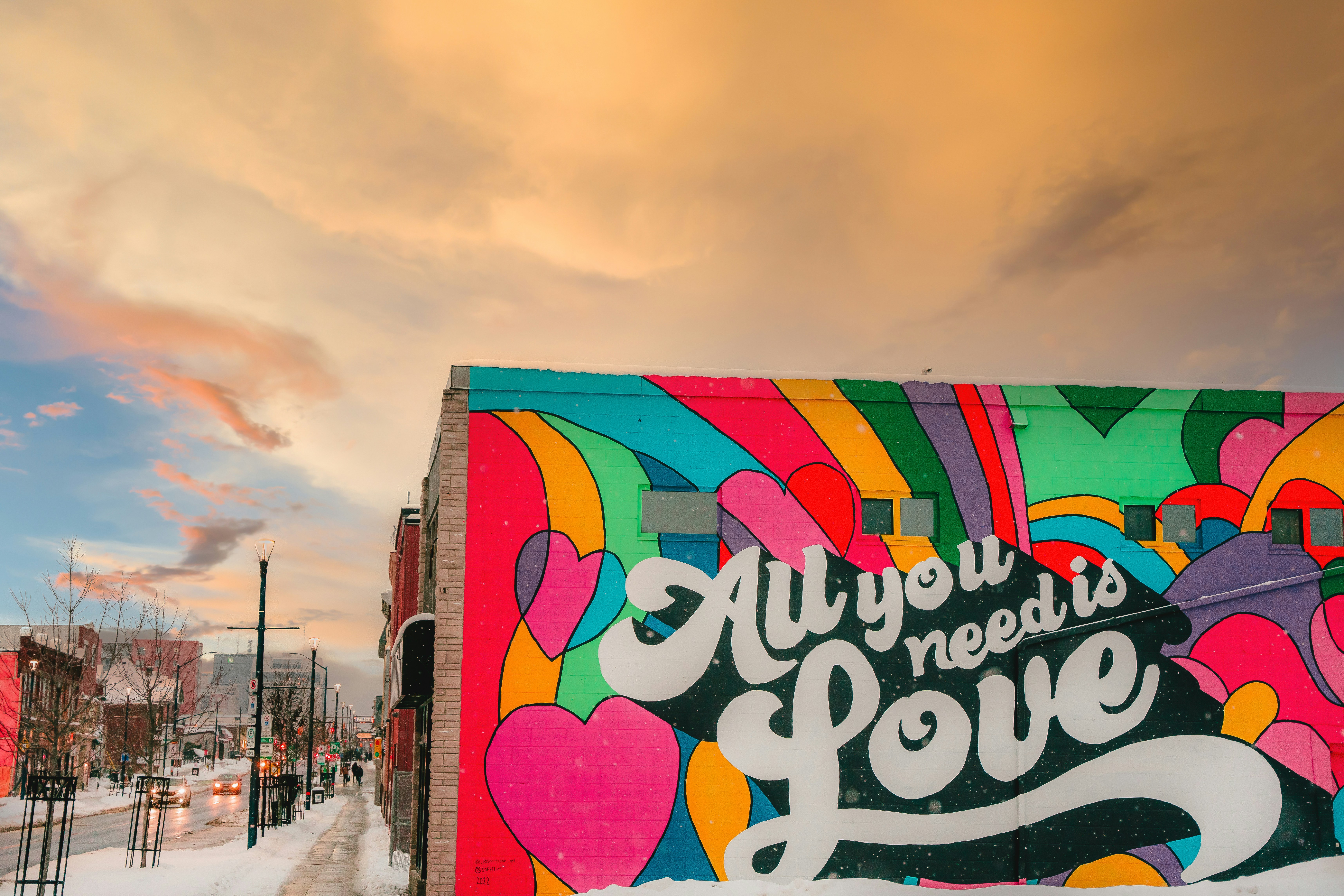 Love in Neon Colors: Mural of Hearts and Script on Sunset Wall