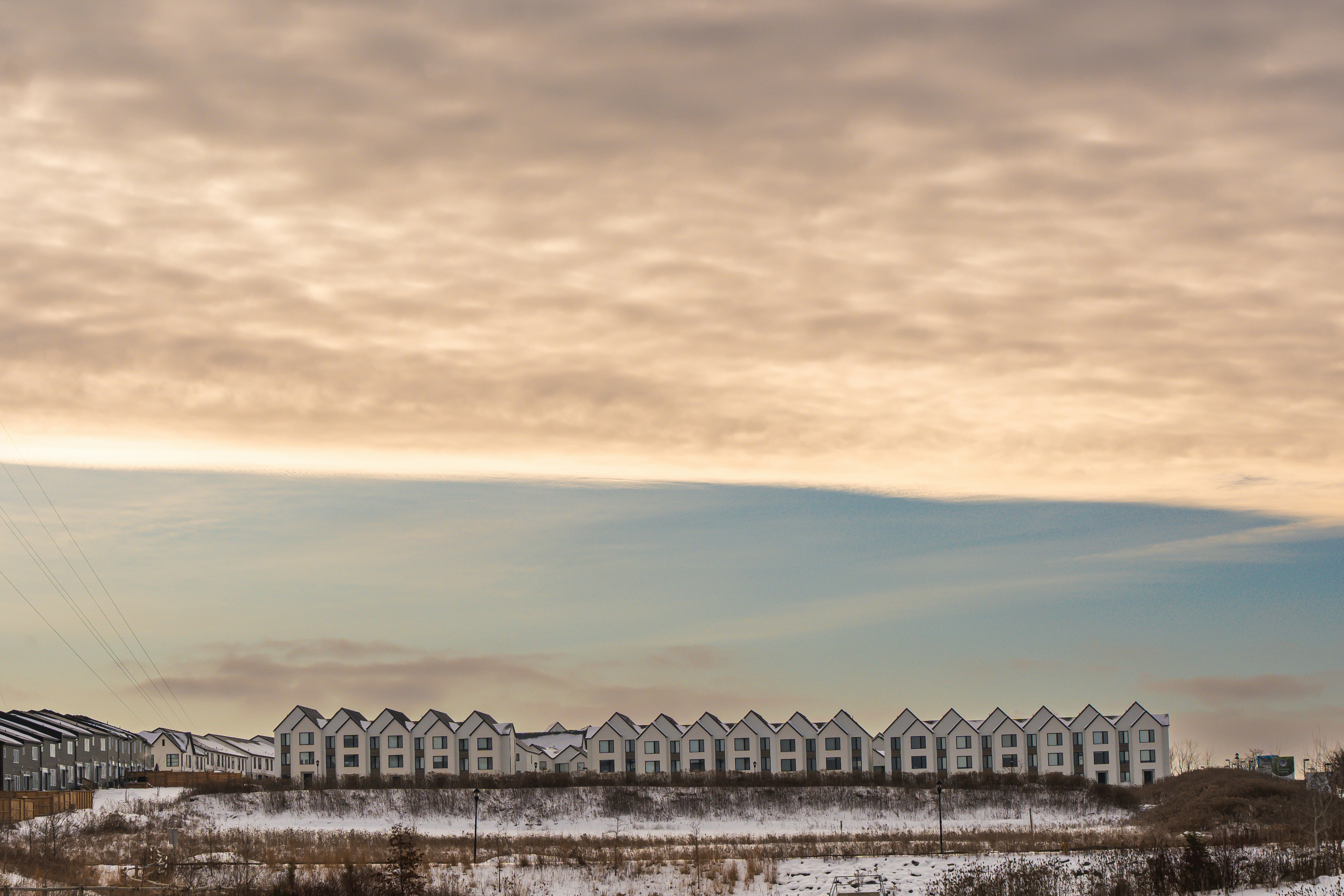 Row of Snowbound Townhomes under a Painted Sky