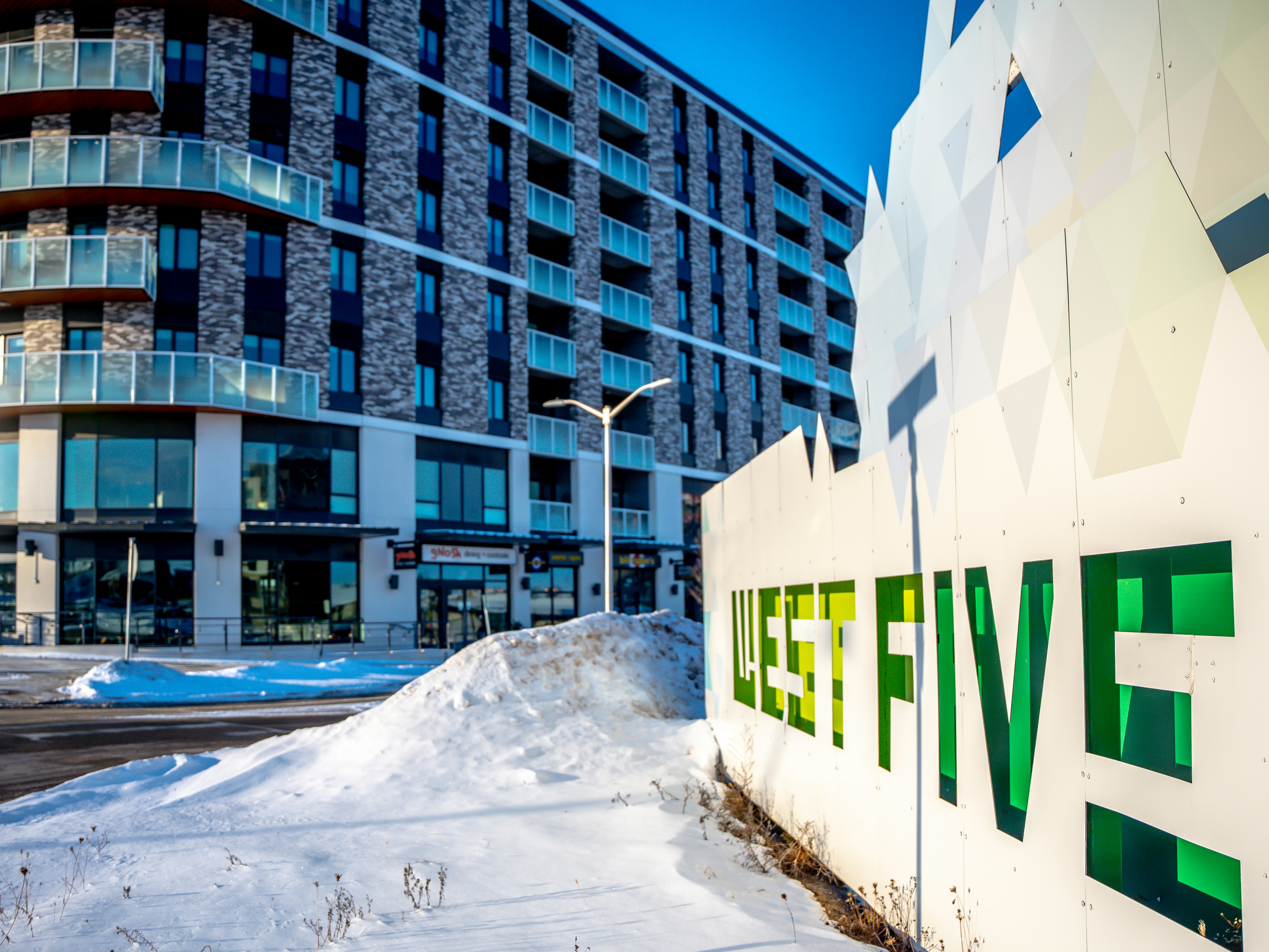 City Edge: Snow, Shadow, and the Green Let Five Sign