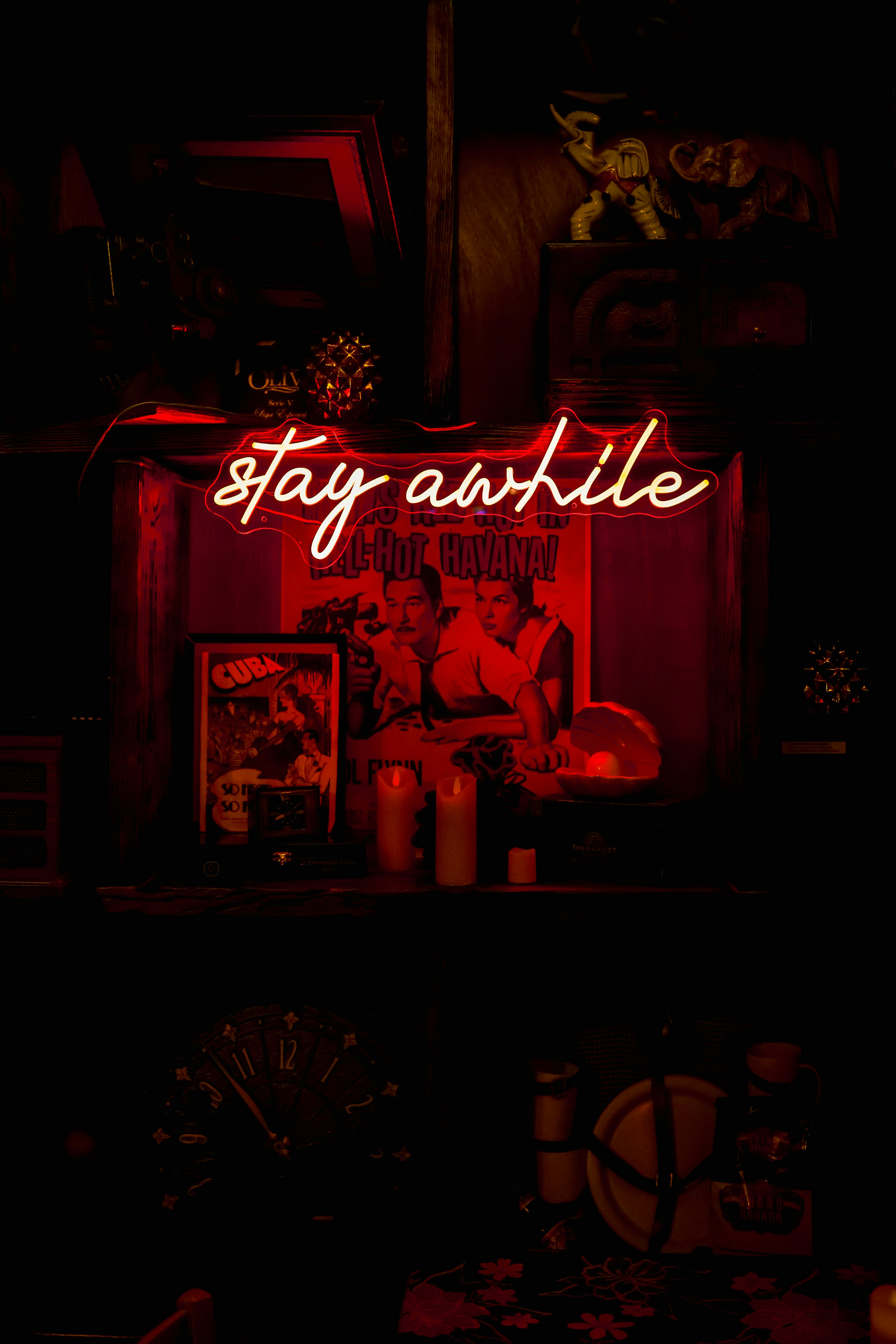 Neon Whisper: A Midnight Shelf with Stay Awhile Sign